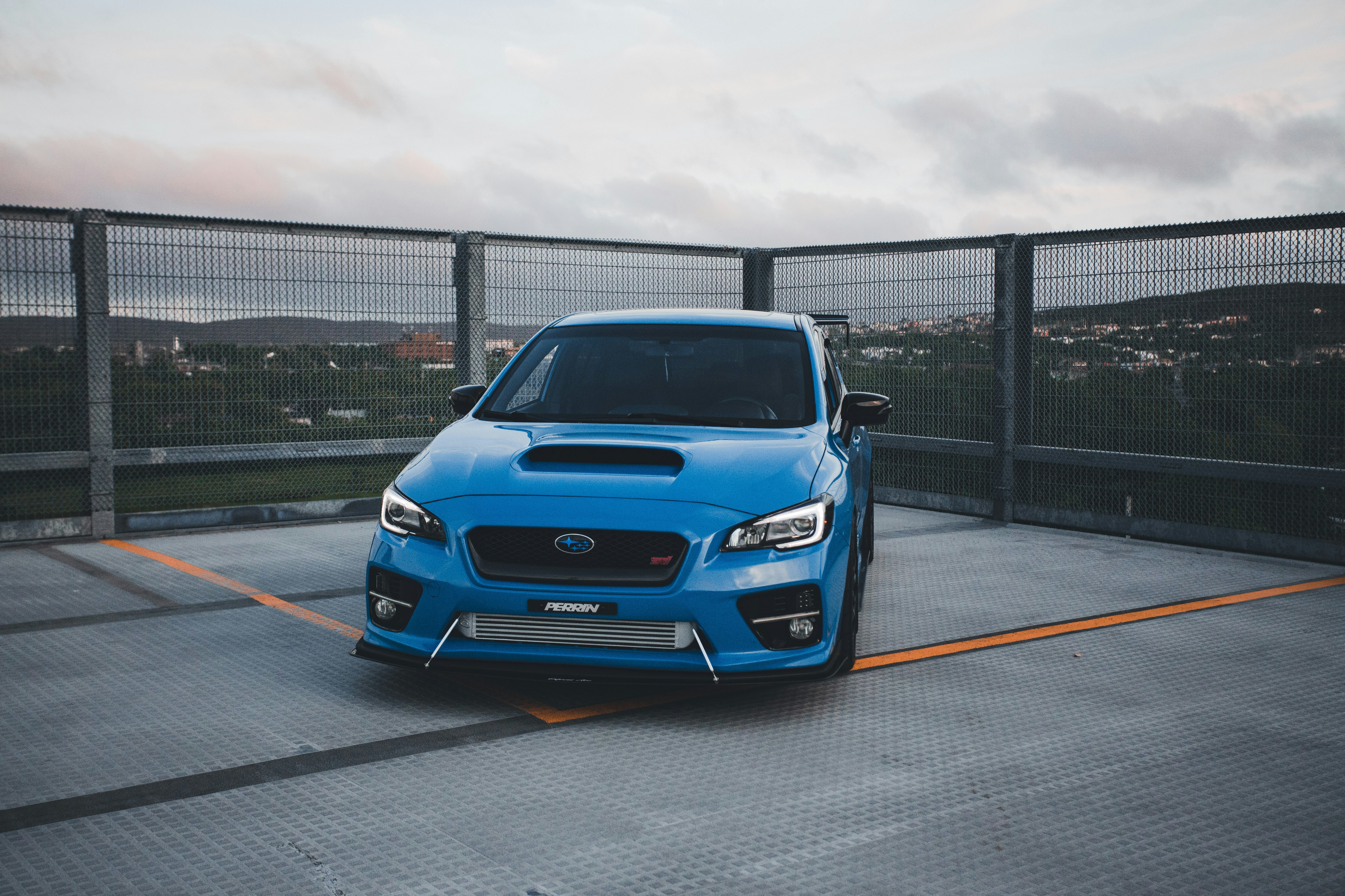 A blue car on a race track photo – Free Blue Image on Unsplash