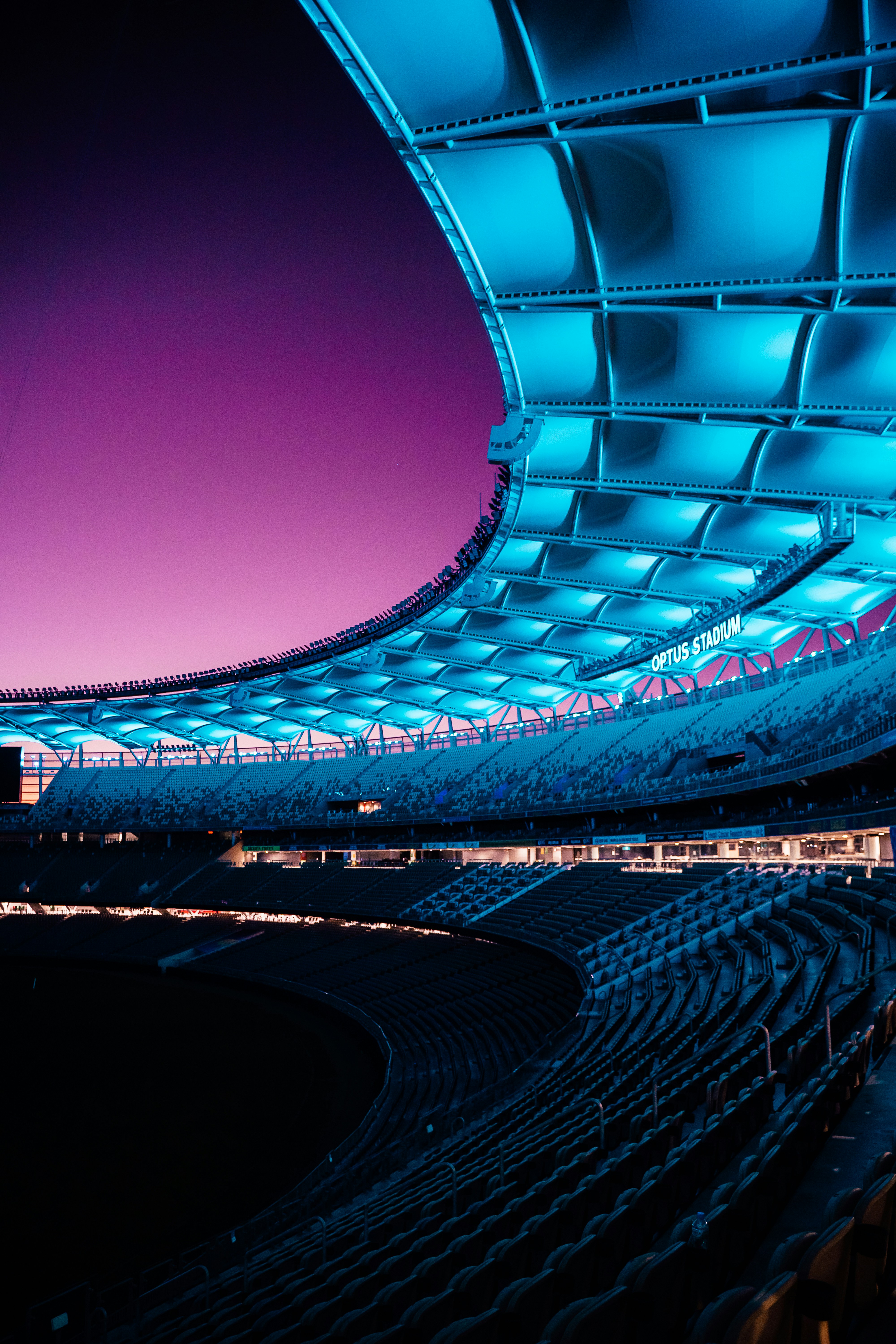 Under the Neon Roof: An Arena Bathed in Gradient Twilight