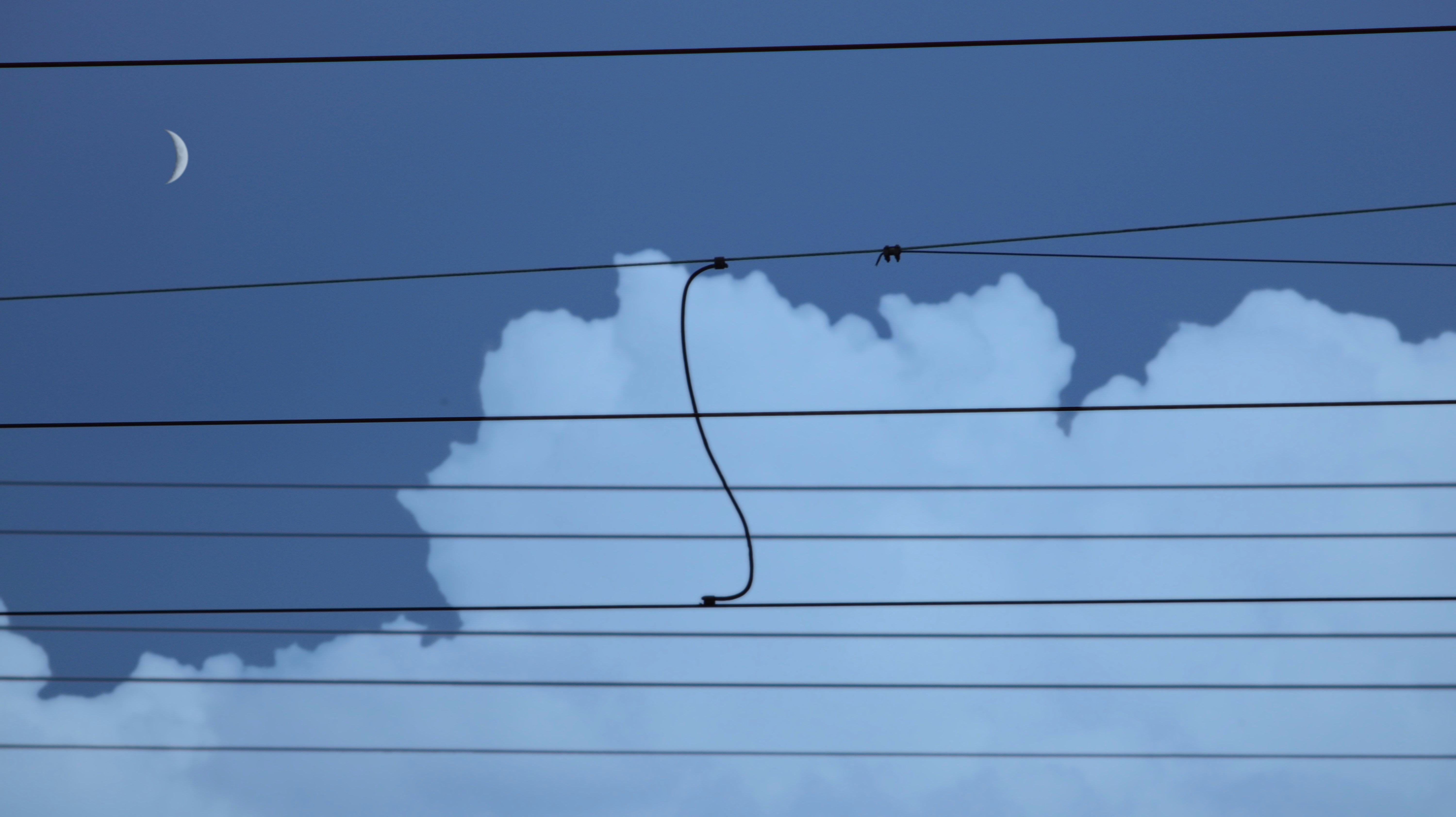 Arc in the Cable Sky: A Minimalist Portrait of Light and Line