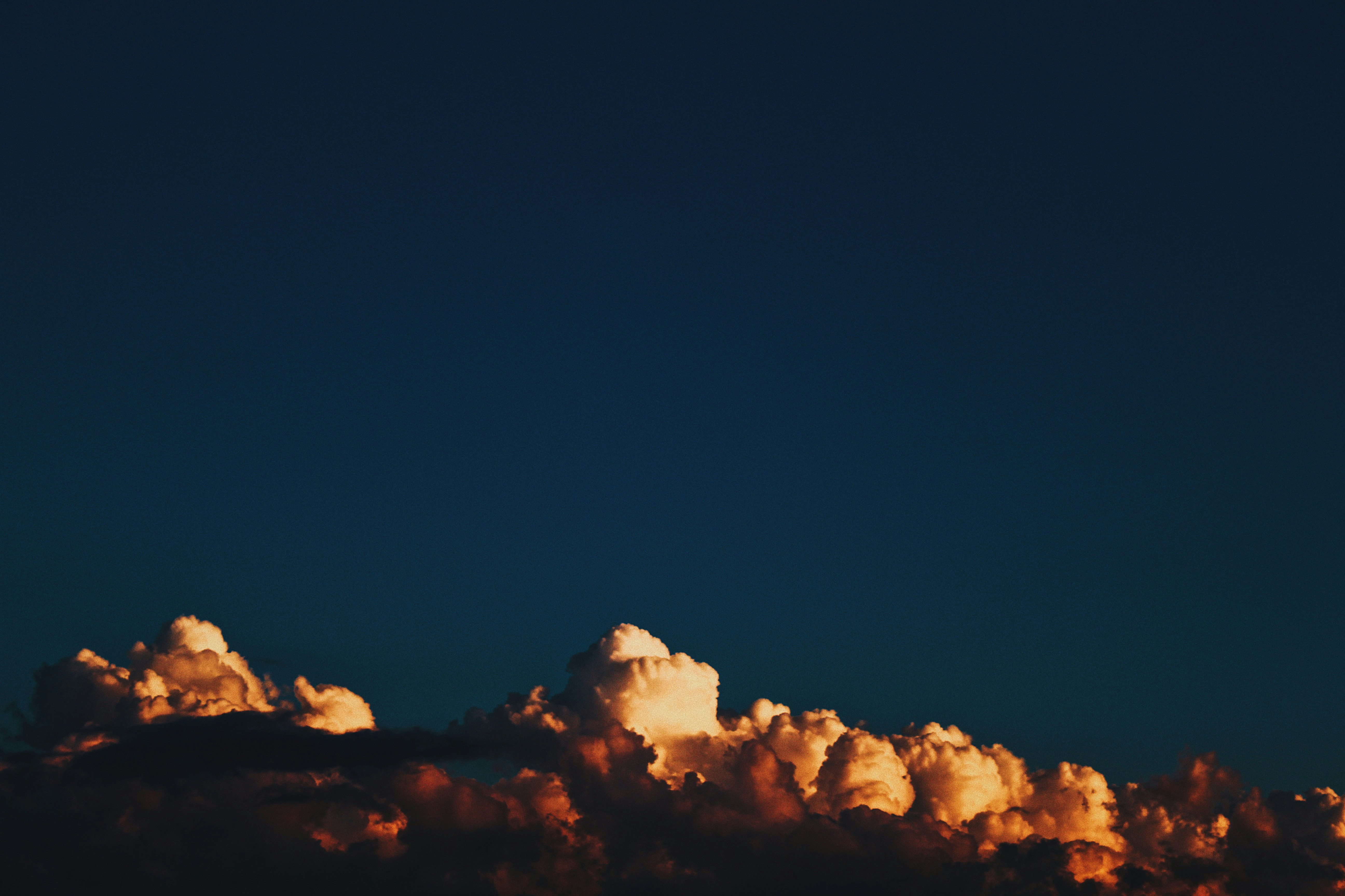 Ember Clouds Framing a Quiet Horizon at Dusk
