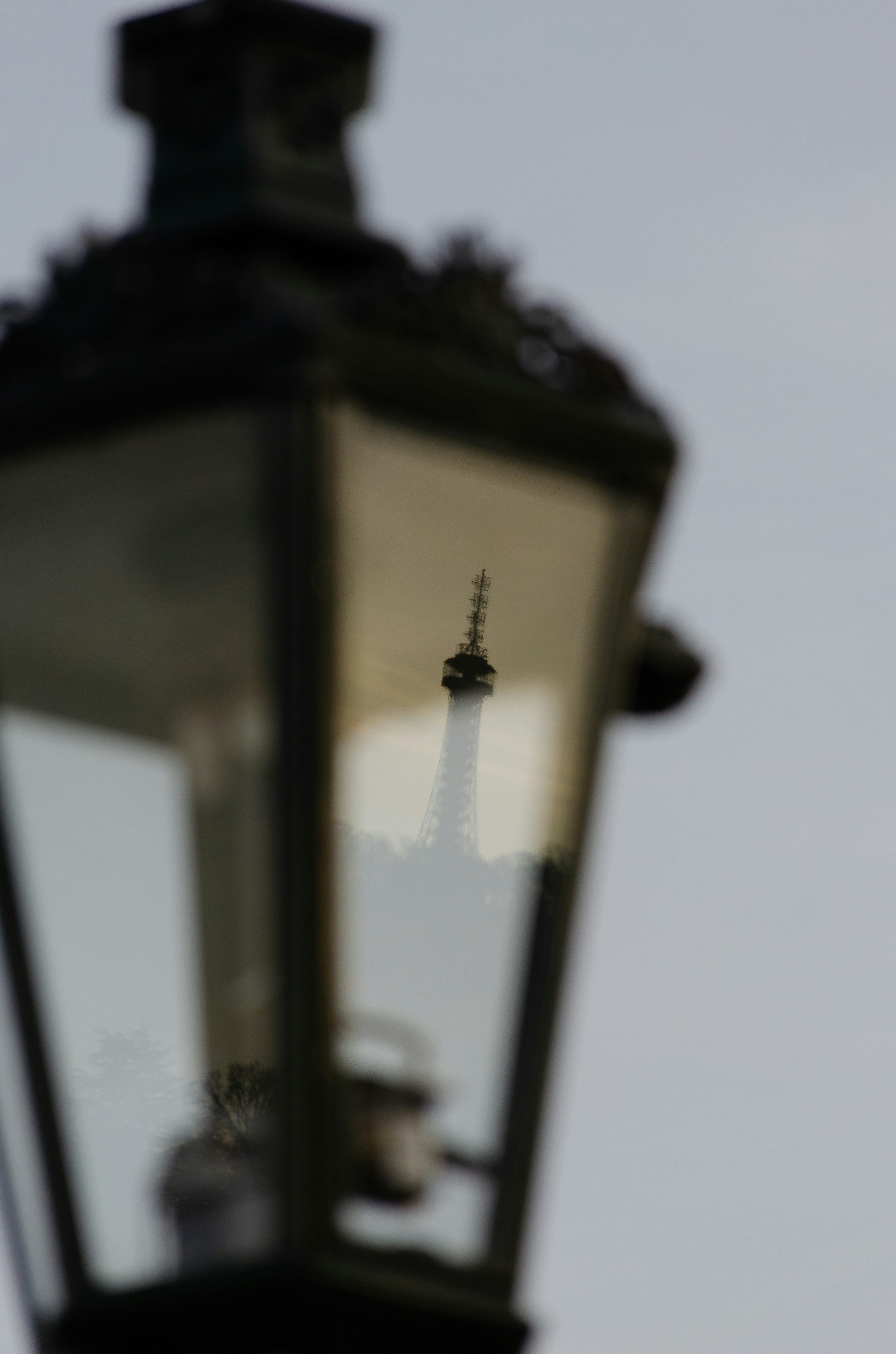 Lantern Glass Echo: A Subtle Eiffel Tower Reflection