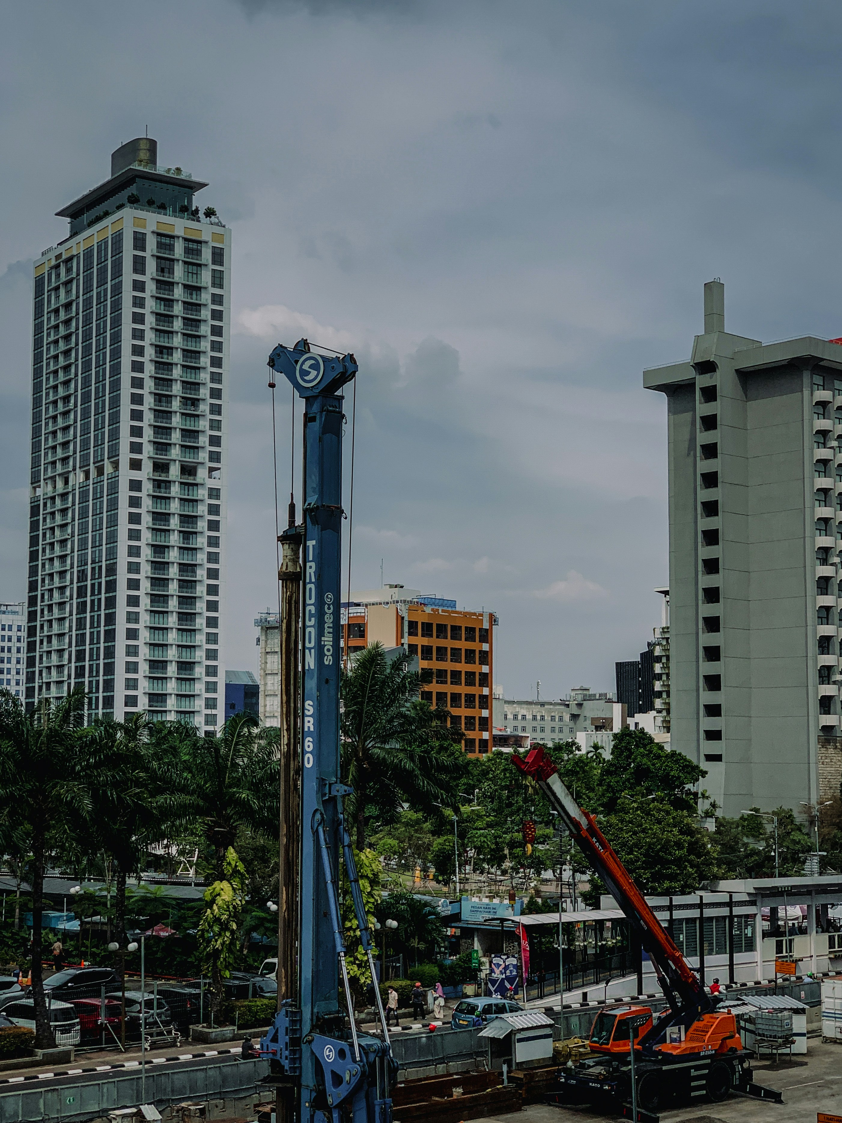 Crane Row: Urban Construction Amid Skyscrapers