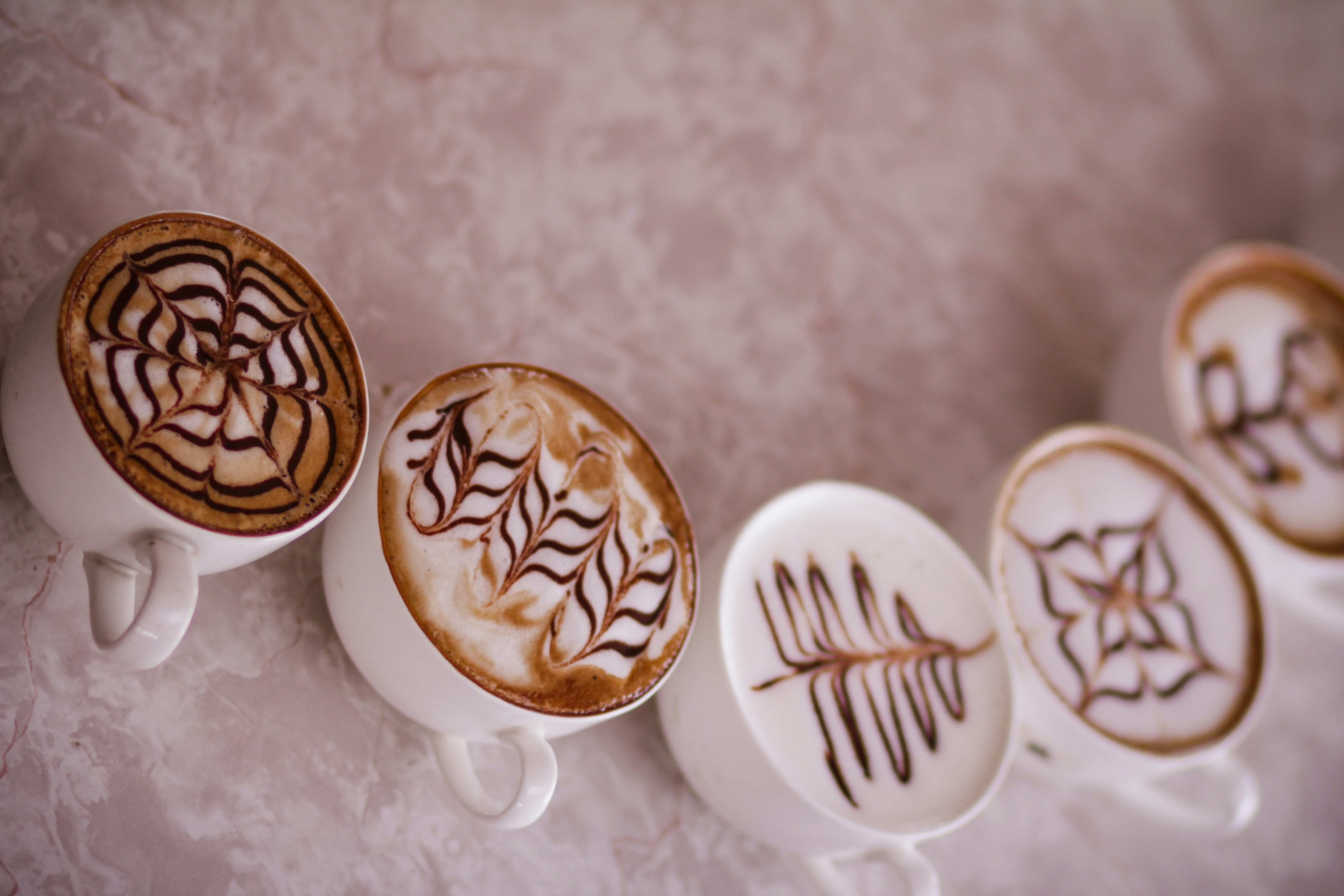 A group of coffee mugs with designs on them photo – Free Brown Image on ...