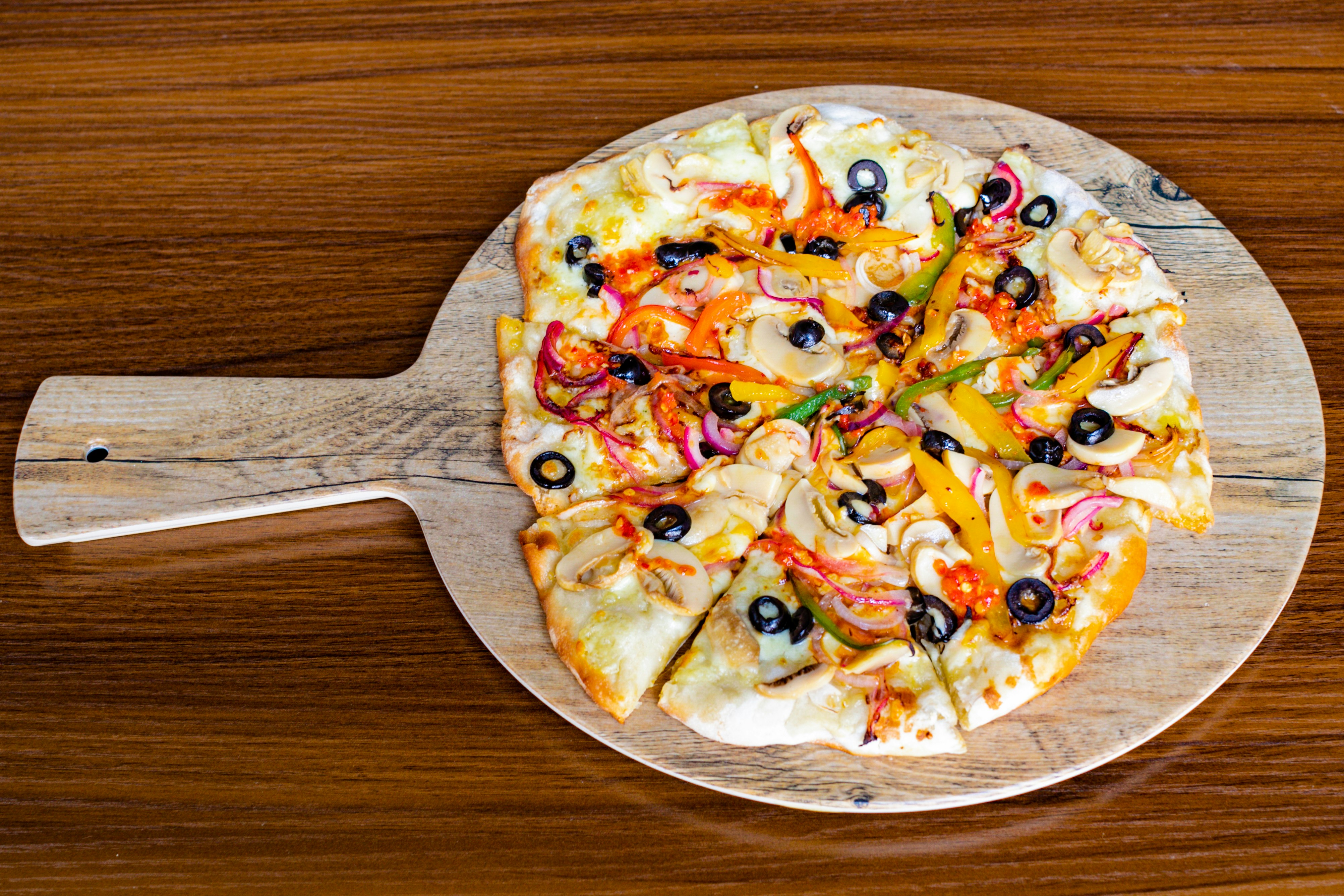 A pizza with cheese and olives photo – Free Image on Unsplash