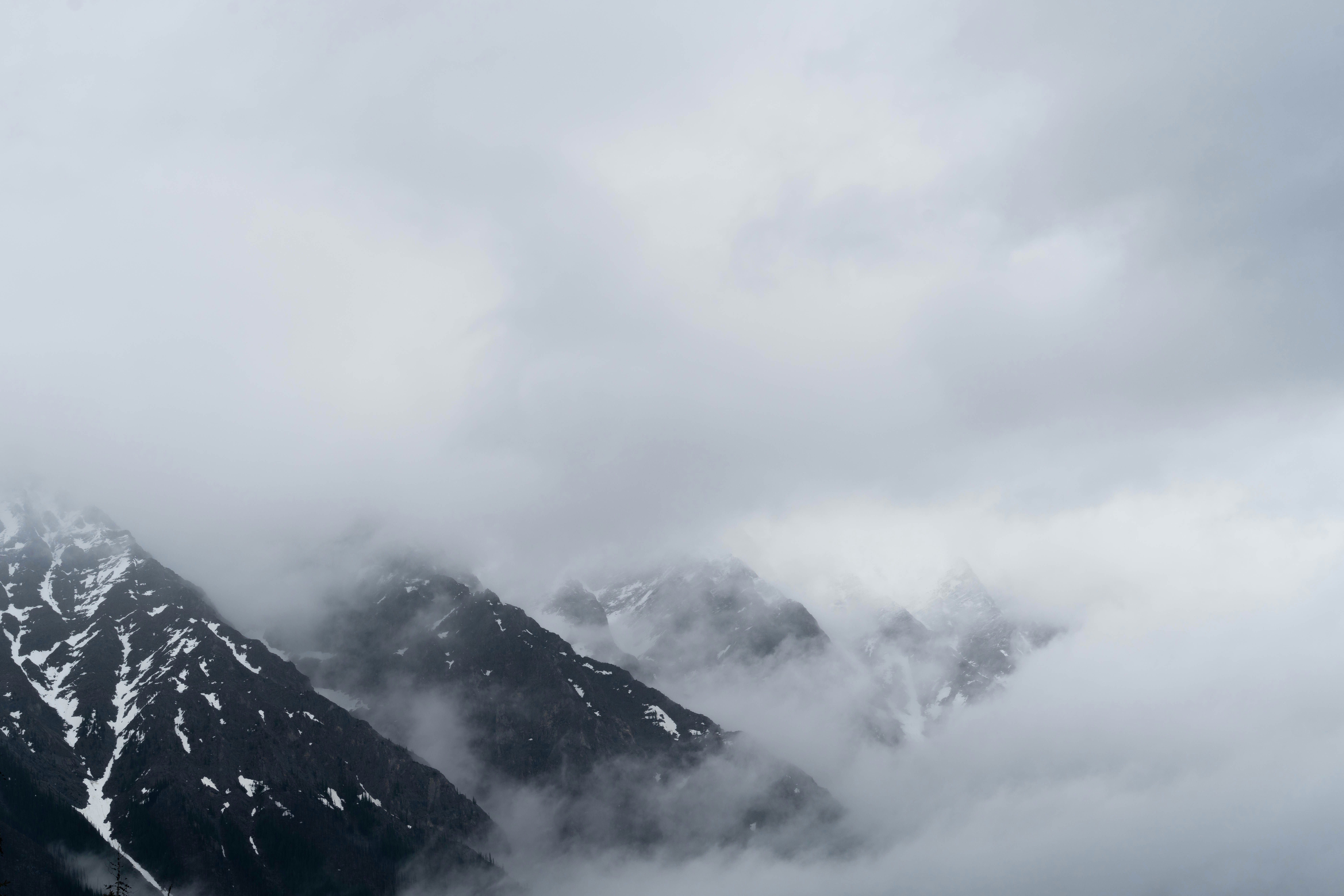 A mountain covered in clouds photo – Free Grey Image on Unsplash