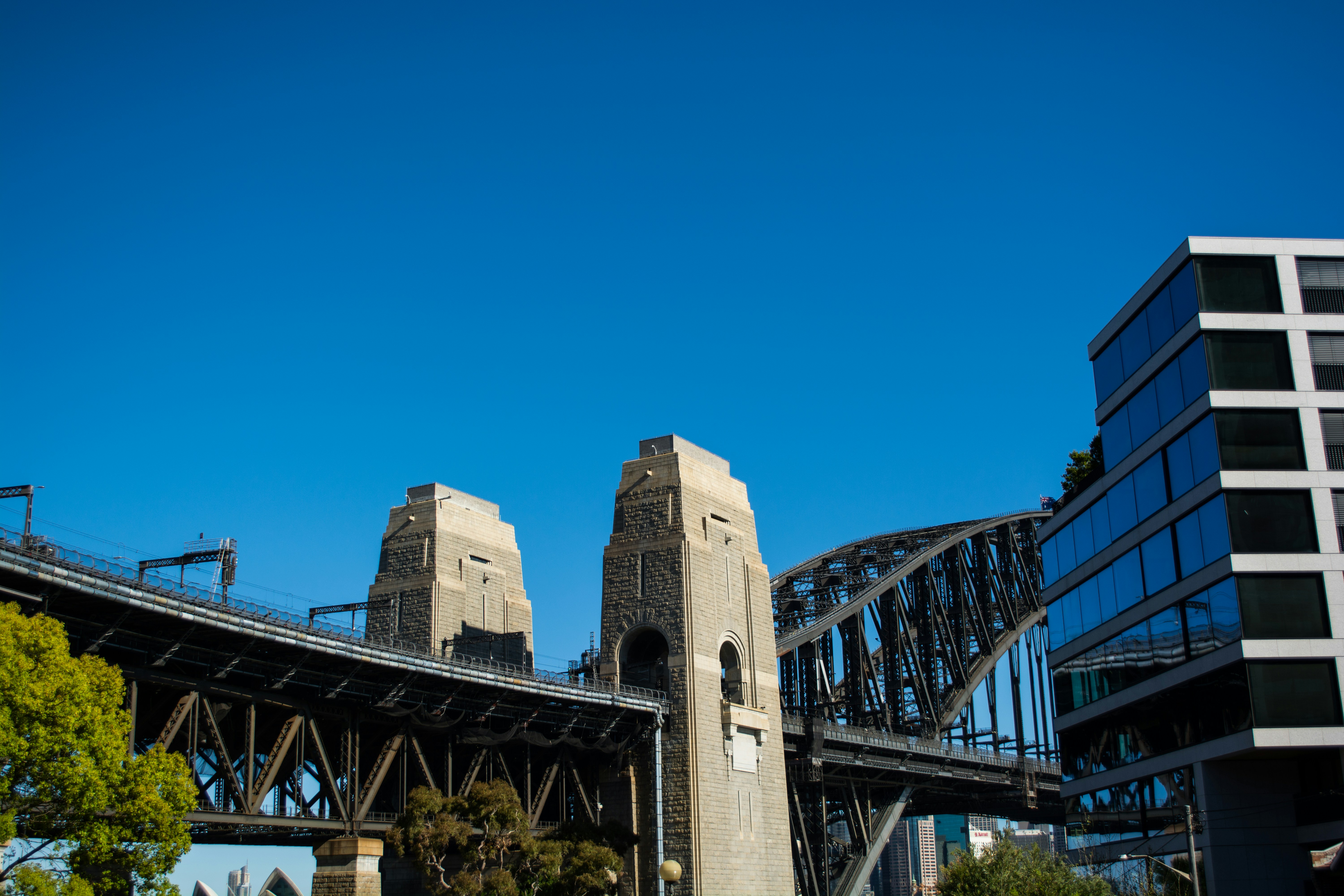 Stone Pillars Framing a Steel Arch Beneath a Cobalt Sky