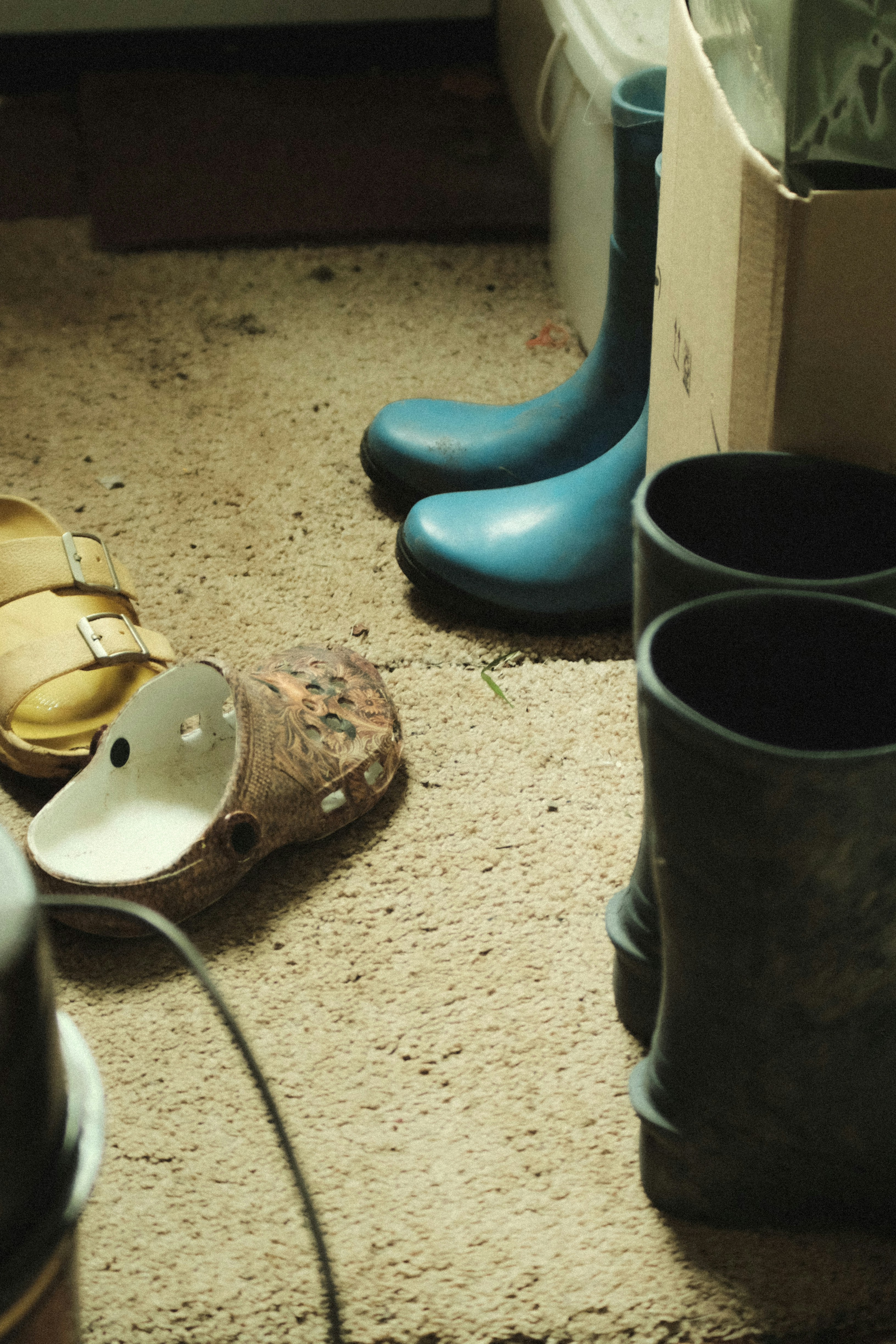 Boots and Slippers Stacked in a Quiet Mudroom Corner