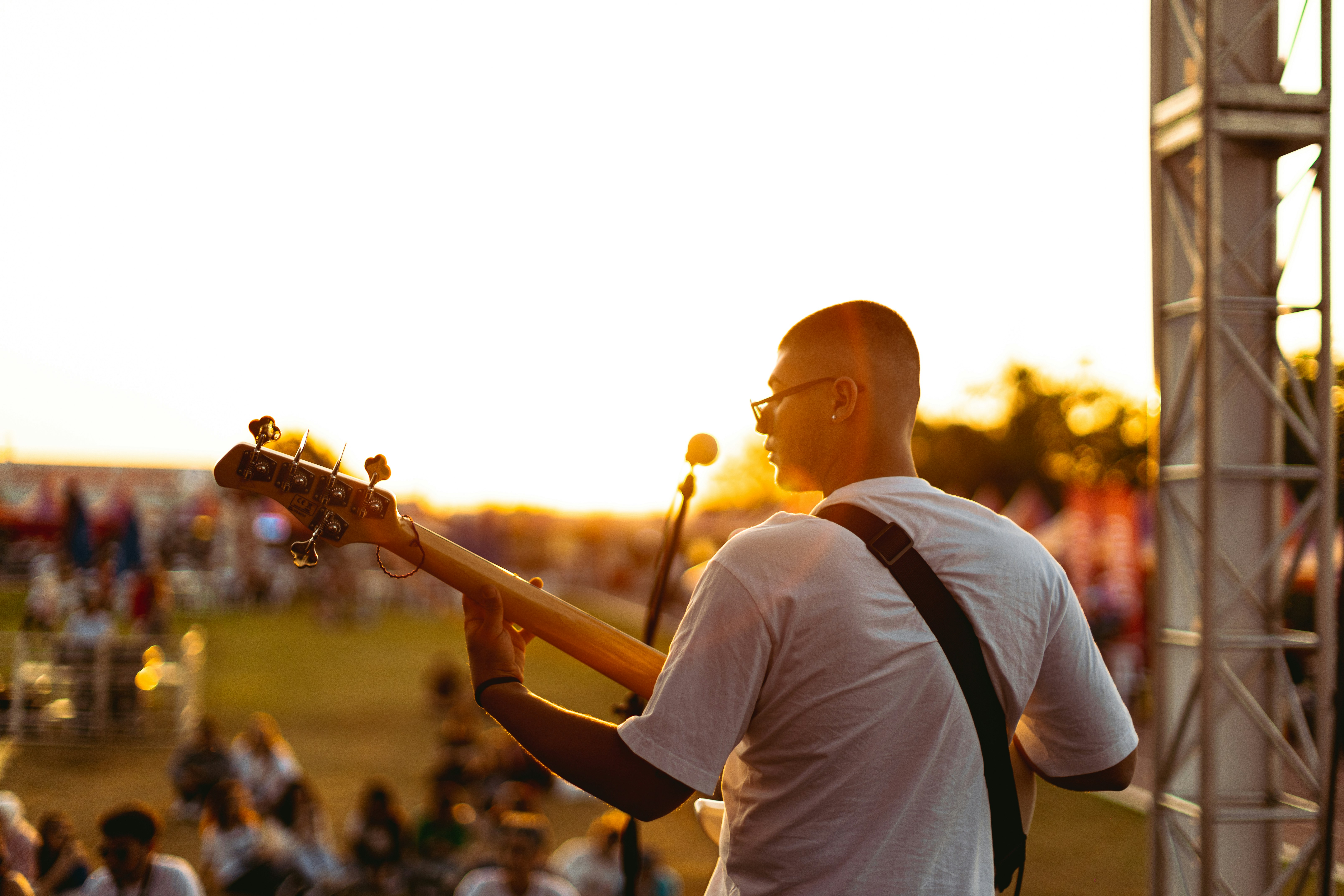 Backlit Bassist Under Golden Hour Spotlight