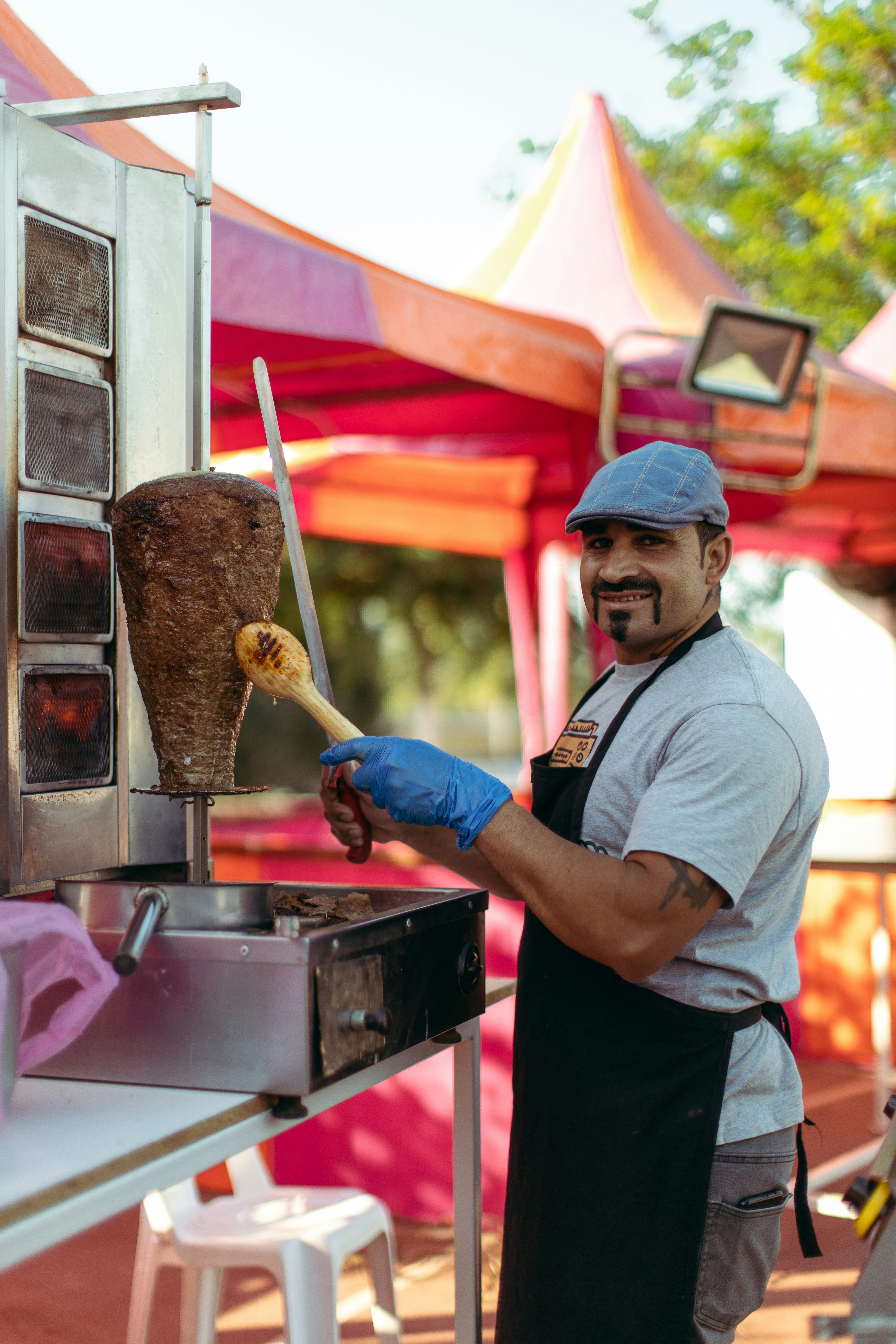 Sunlit Shawarma Stand: The Grilling Maestro at a Street Fair