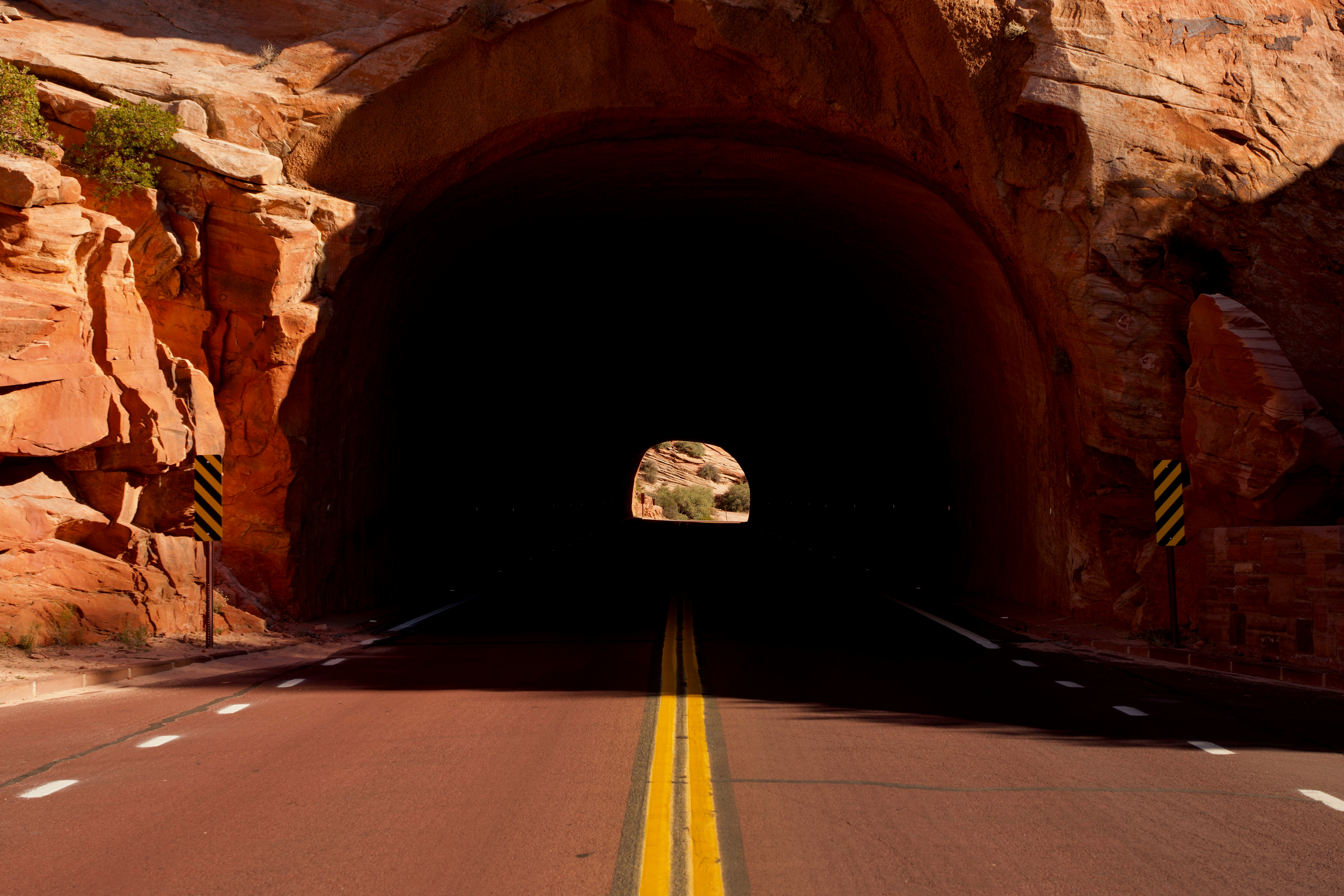 Gateway of Rust: Desert Road Through a Red Rock Tunnel