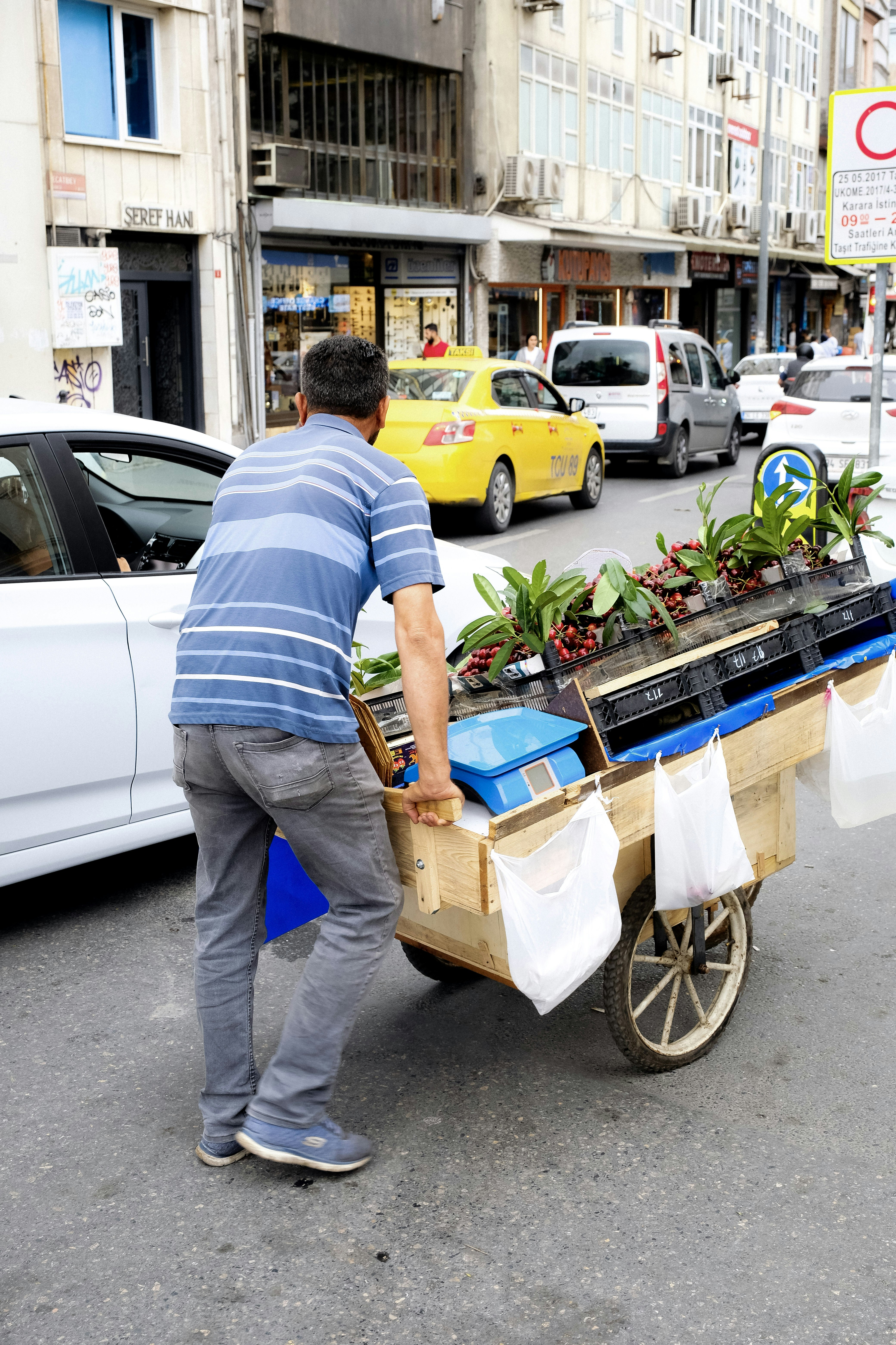 Pushcart of Fresh Greens on a Lively City Street