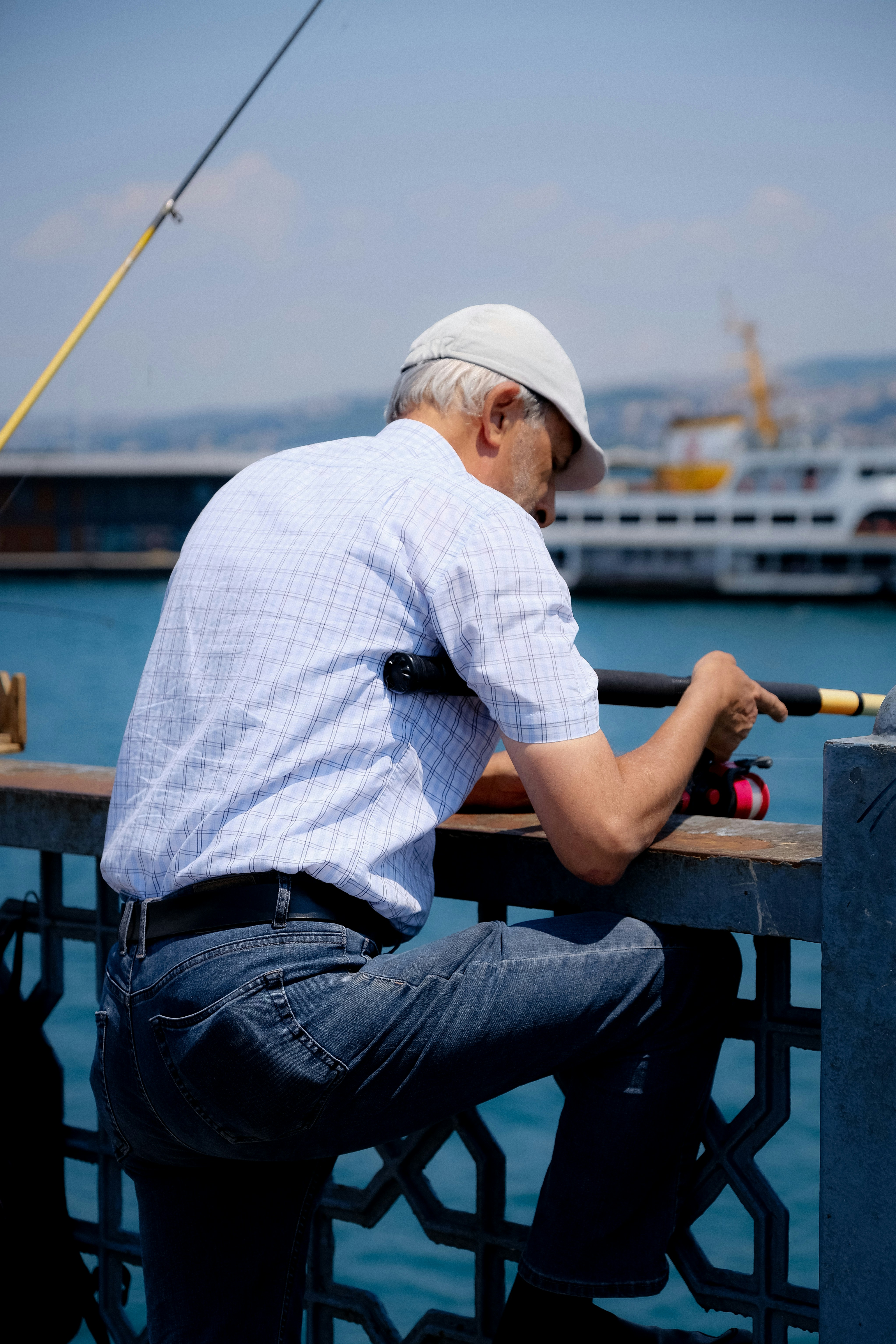 Harbor Quietude: A Fisherman Lost in the Moment