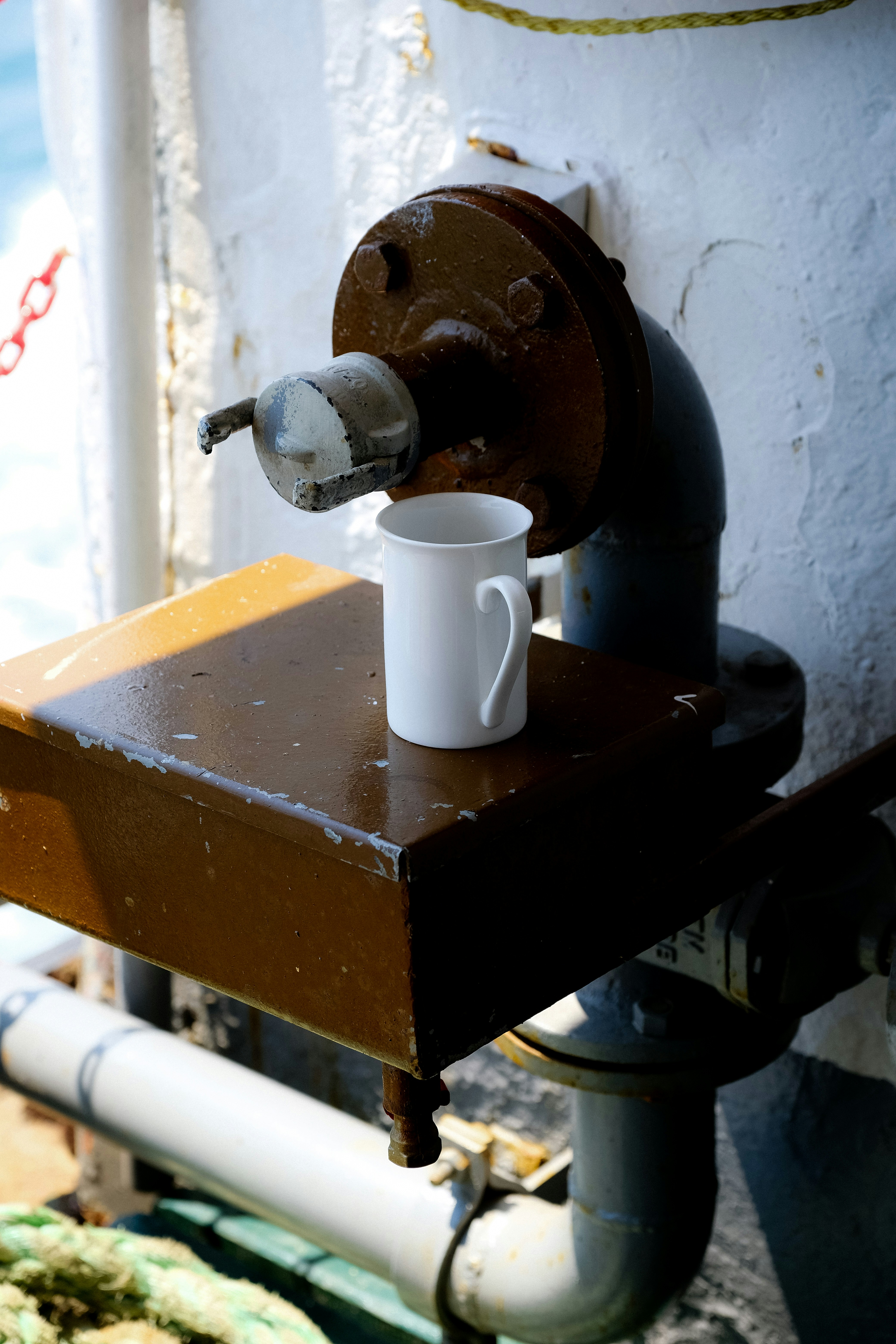 Coffee Cup Under the Rusted Mechanism