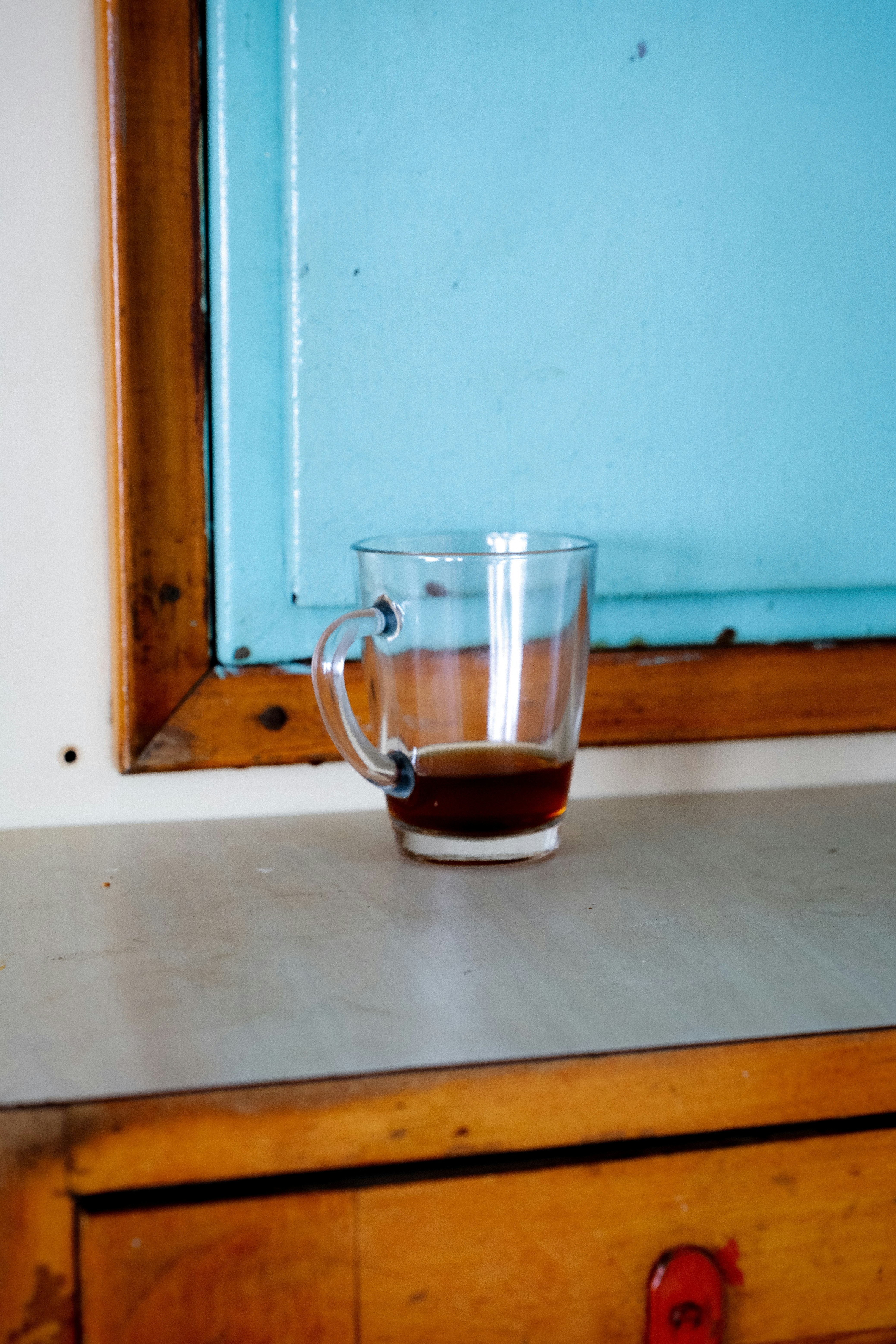 Amber Quiet: A Glass of Night in a Sunlit Kitchen