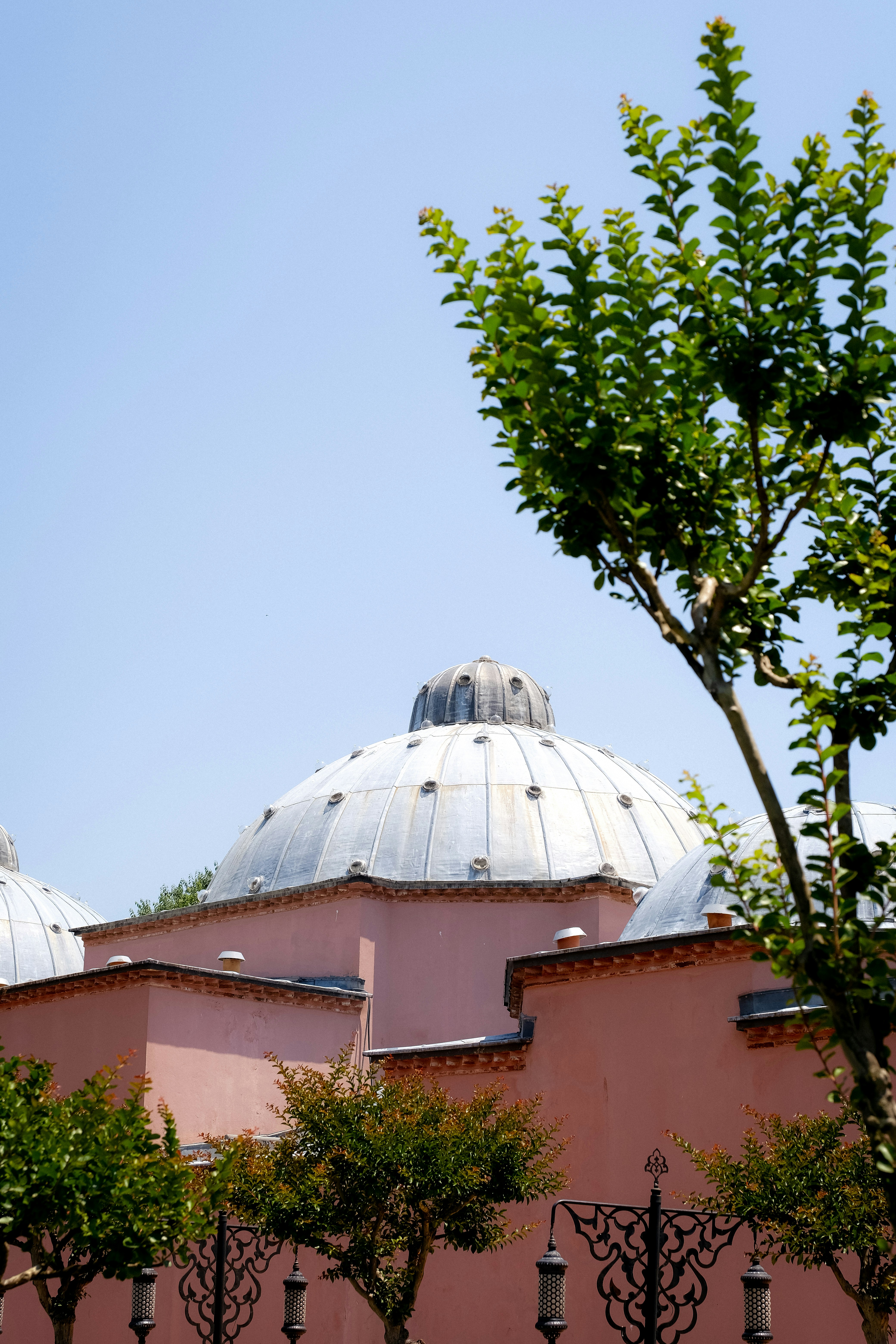 Pink Terraces Beneath a Silvery Dome in a Sunlit Courtyard