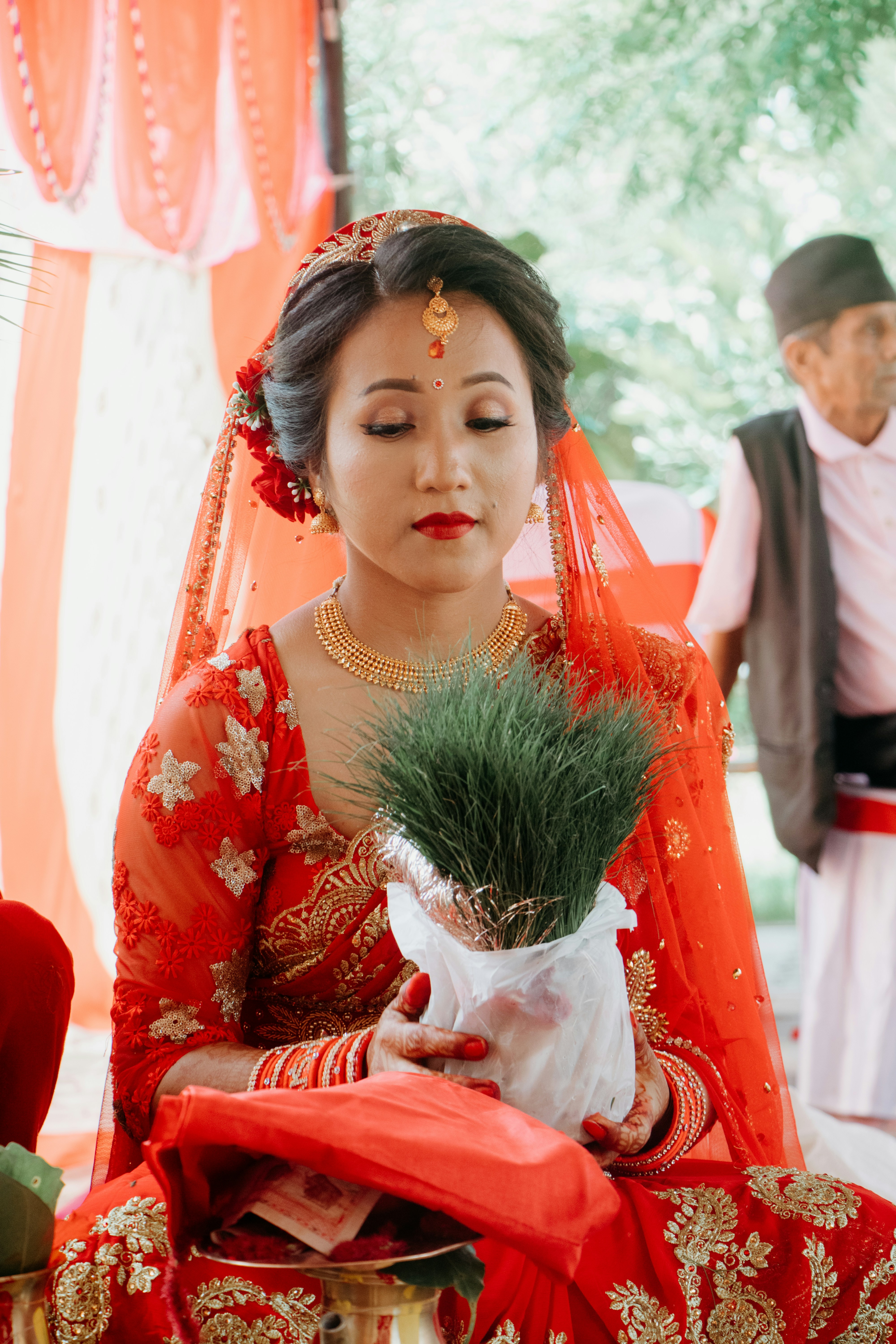 Crimson Veil, Green Keepsake: A Bride in Quiet Ceremony