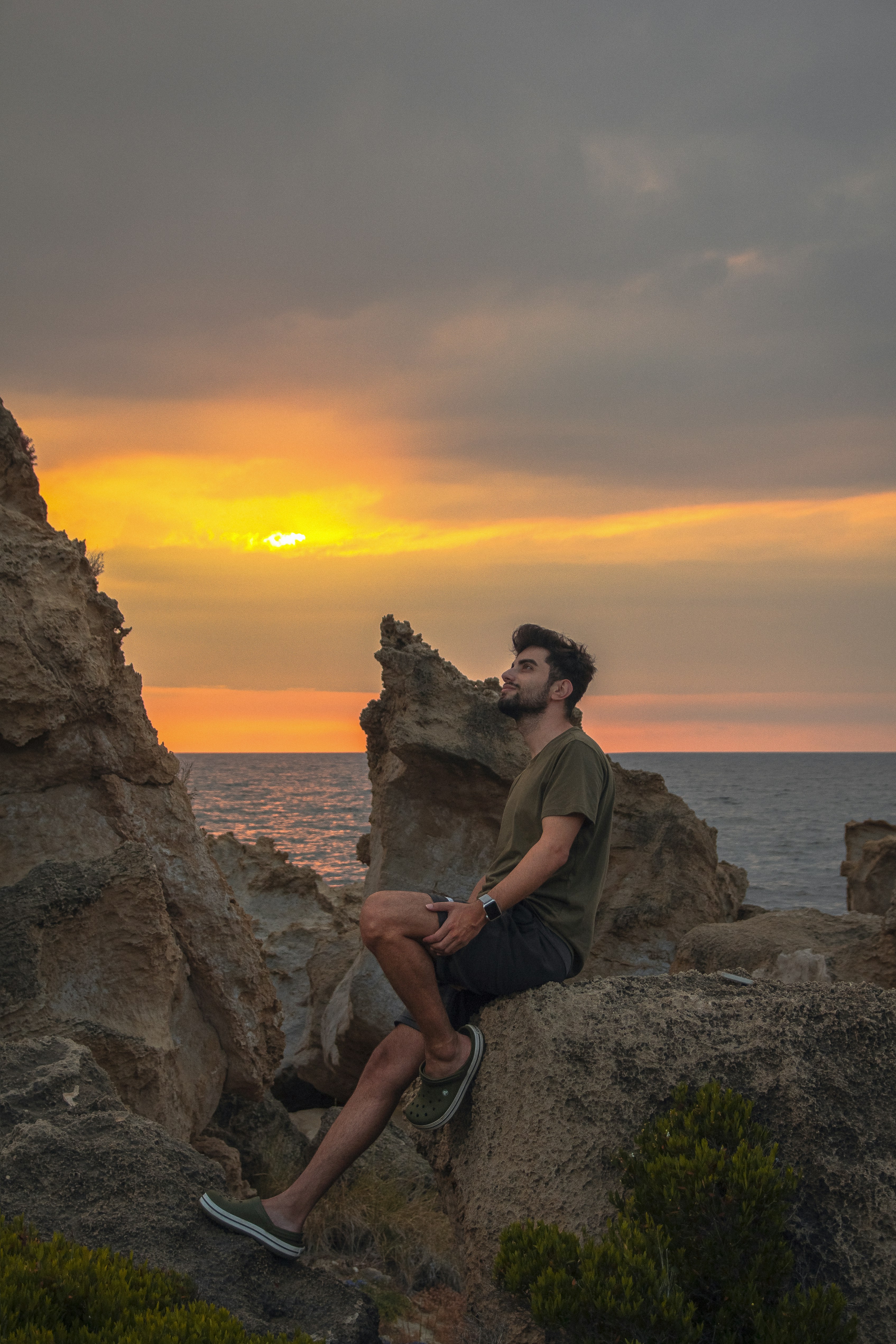 Sunset Silhouette: A Climber Finds Balance Among Tidal Rocks