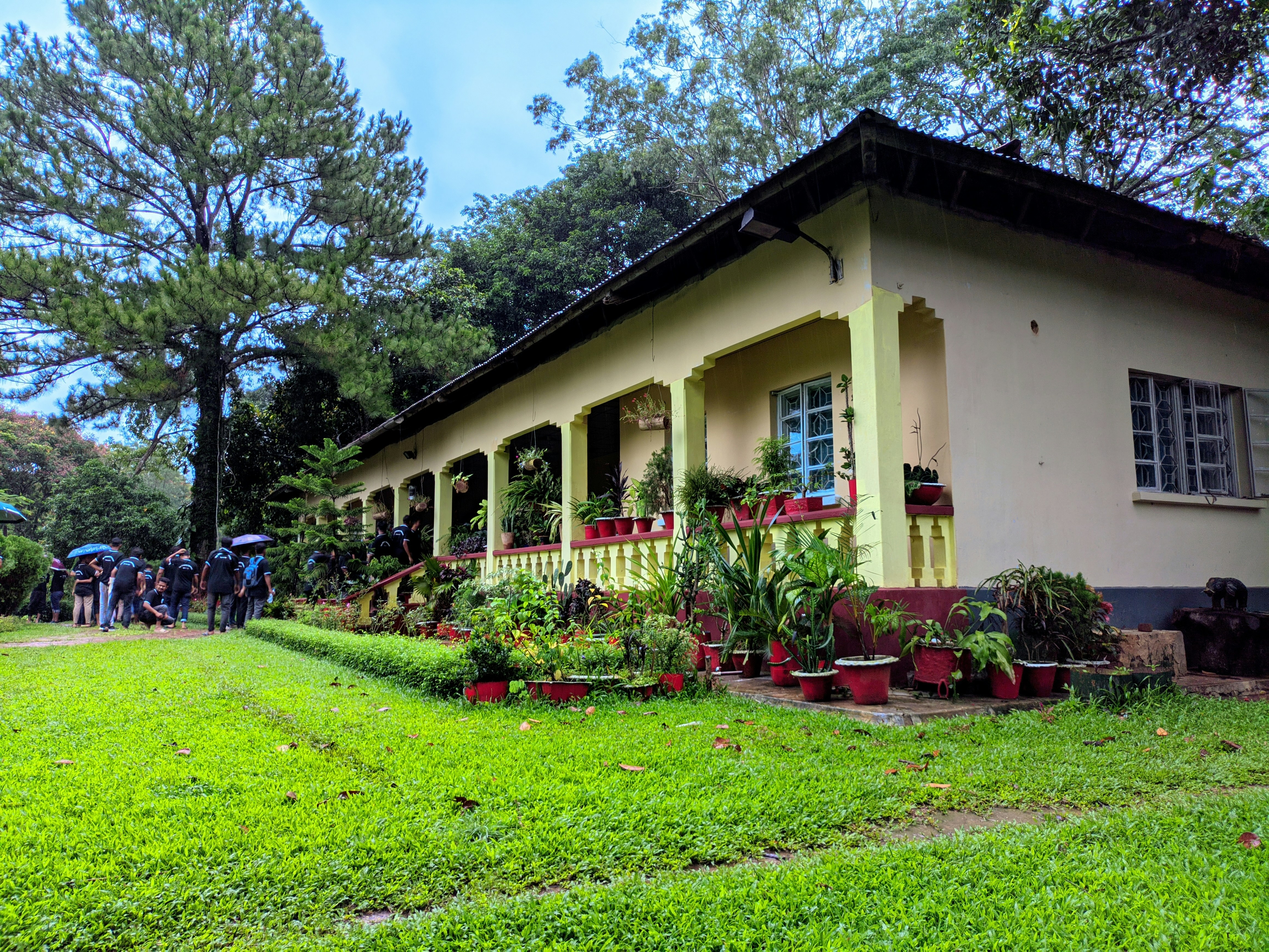 A house with a lawn and people walking around photo – Free Finlay tea ...