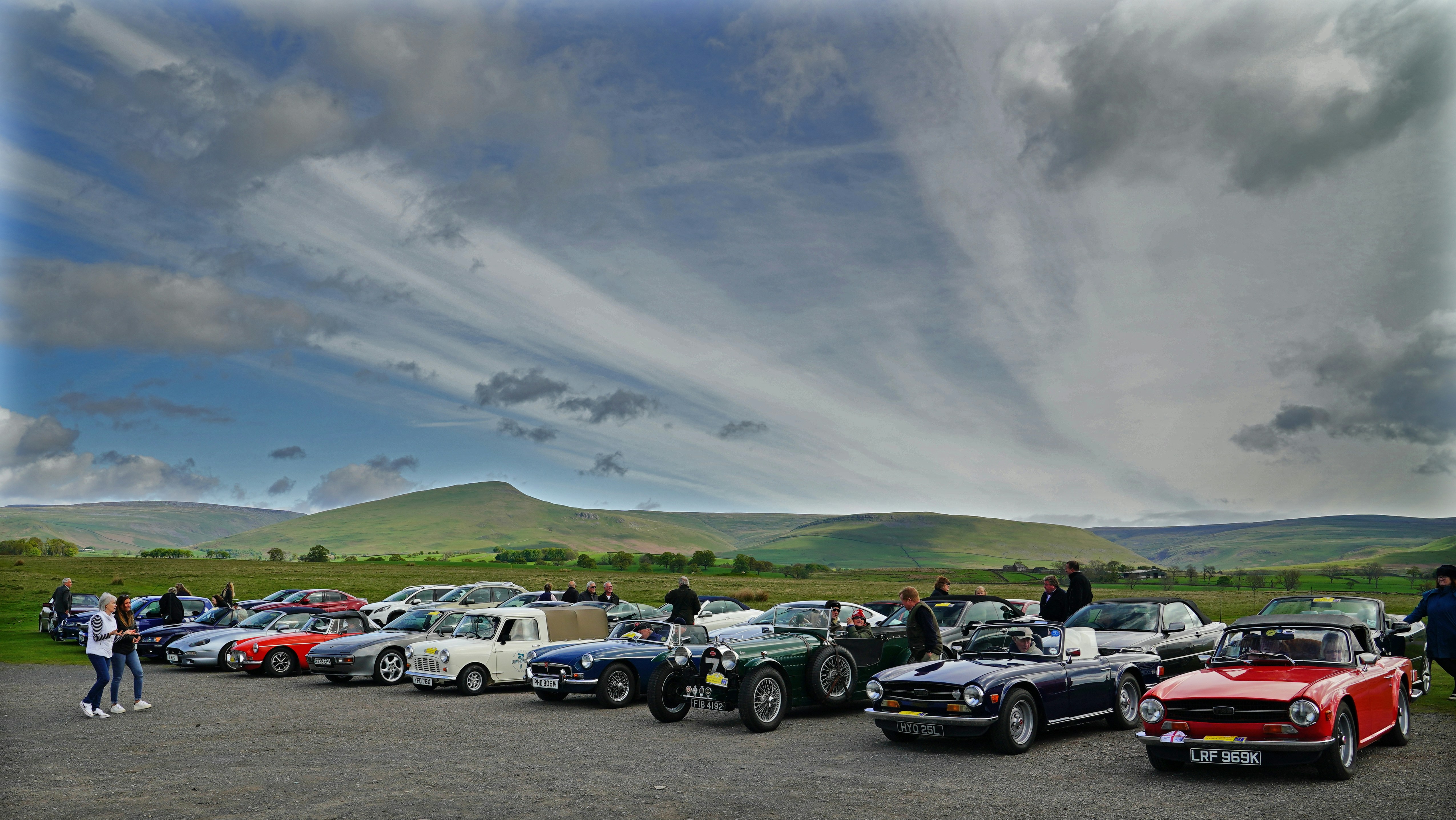 Lineup Under Wide Skies: Vintage Roadsters at a Countryside Car Meet