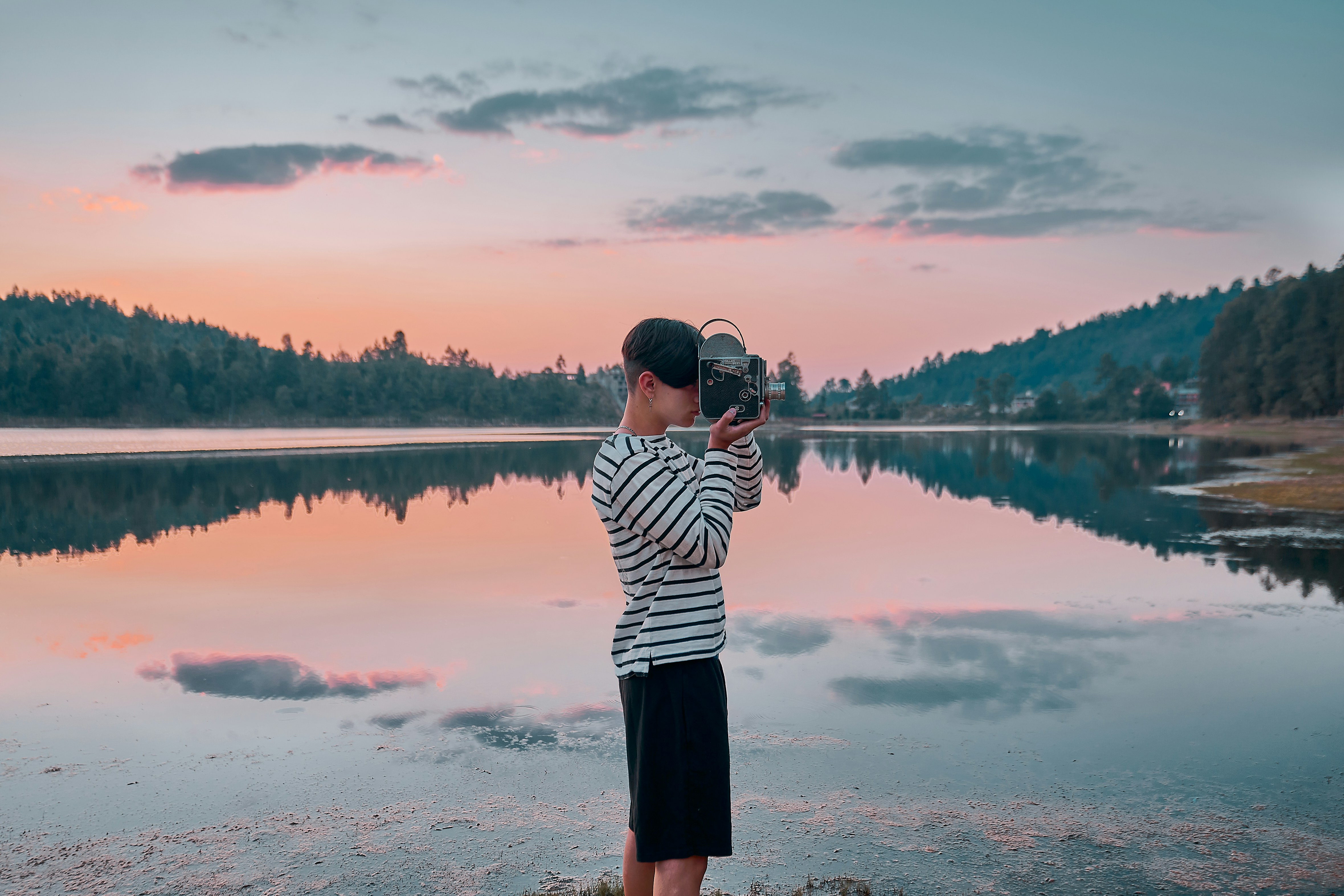 Portrait at Dusk: A Boy with a Viewfinder by the Water