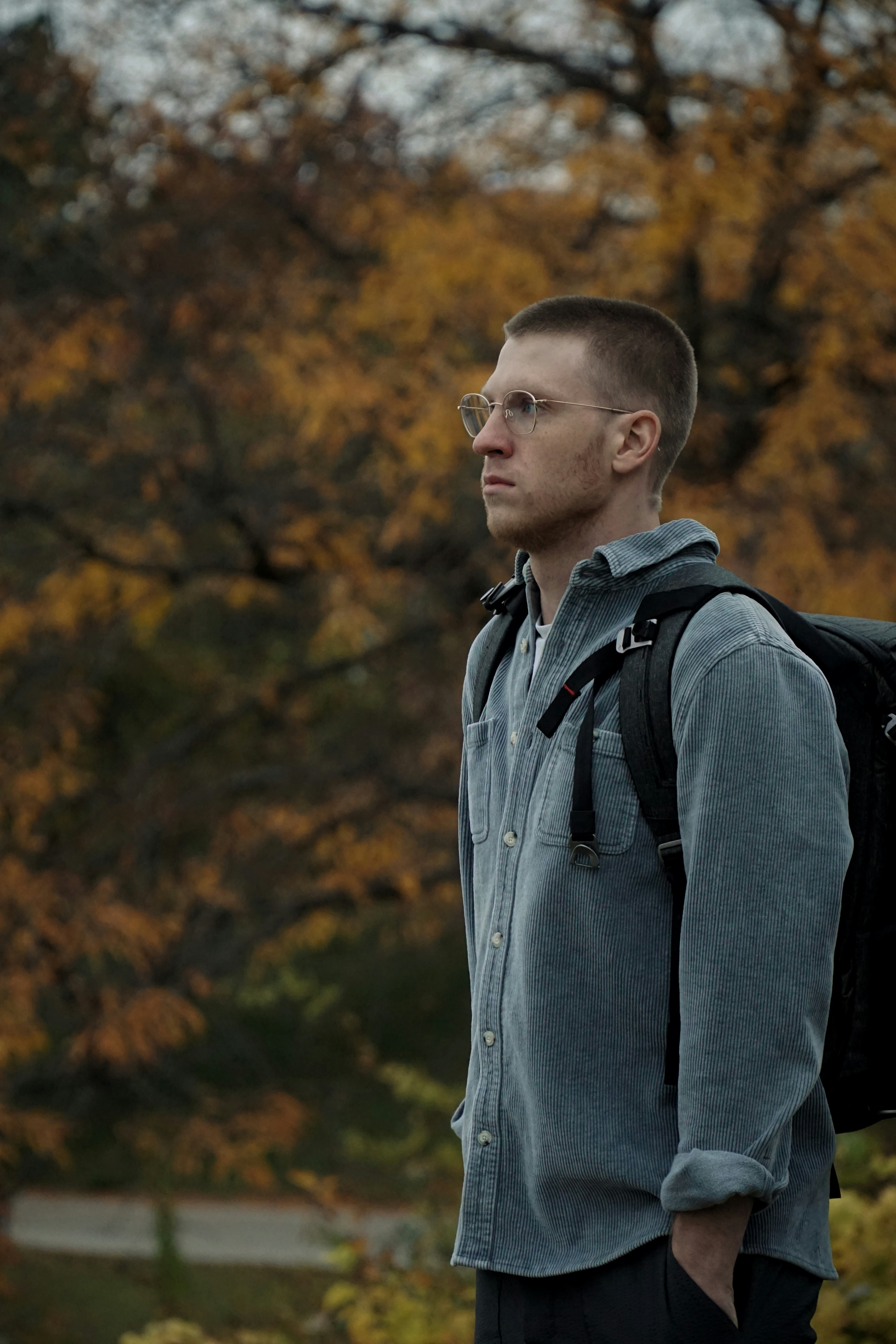 Autumn Portrait: A Quiet Stare Through Glasses in Dusky Park