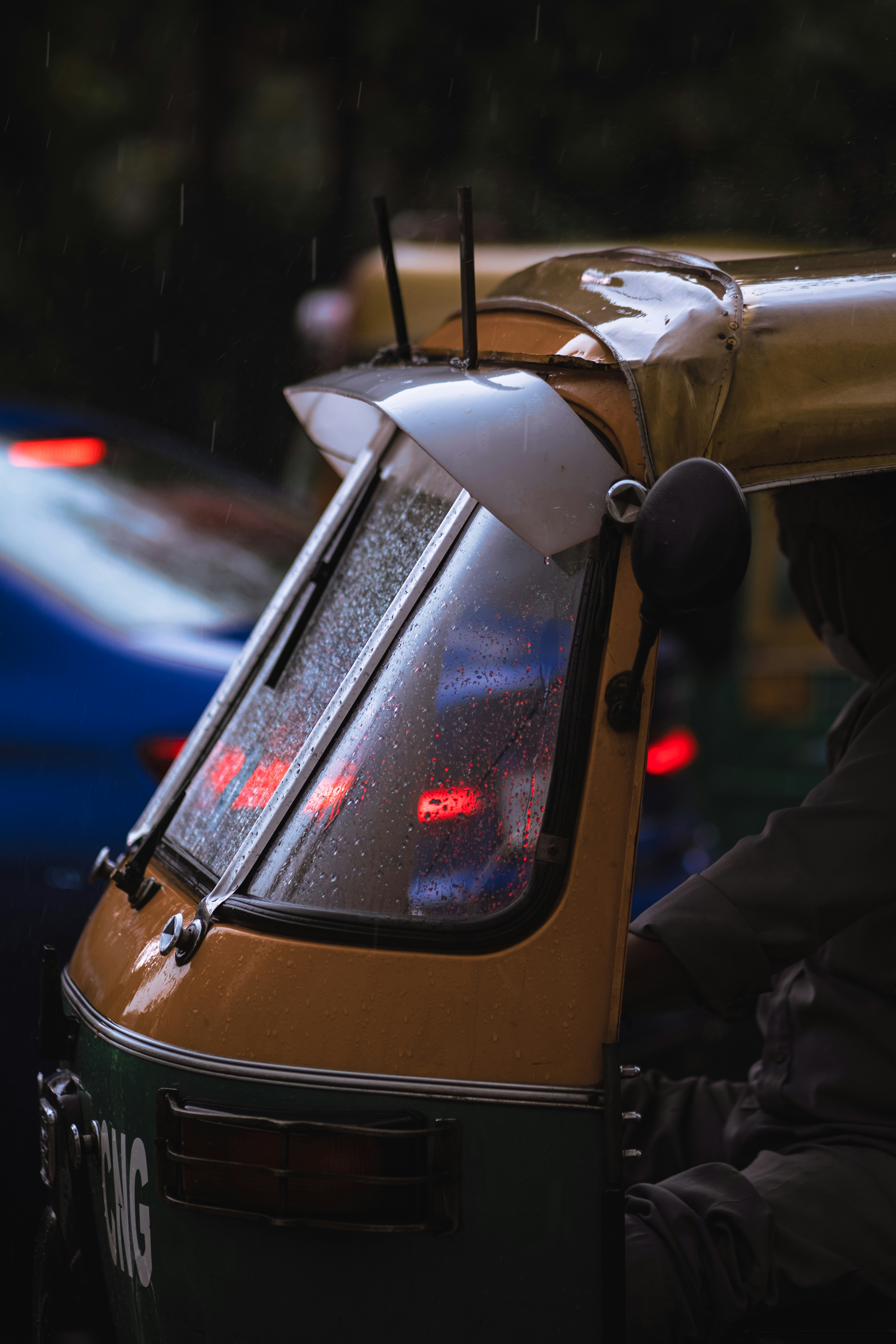 Rain-Soaked Tuk-Tuk under Neon Night Lights