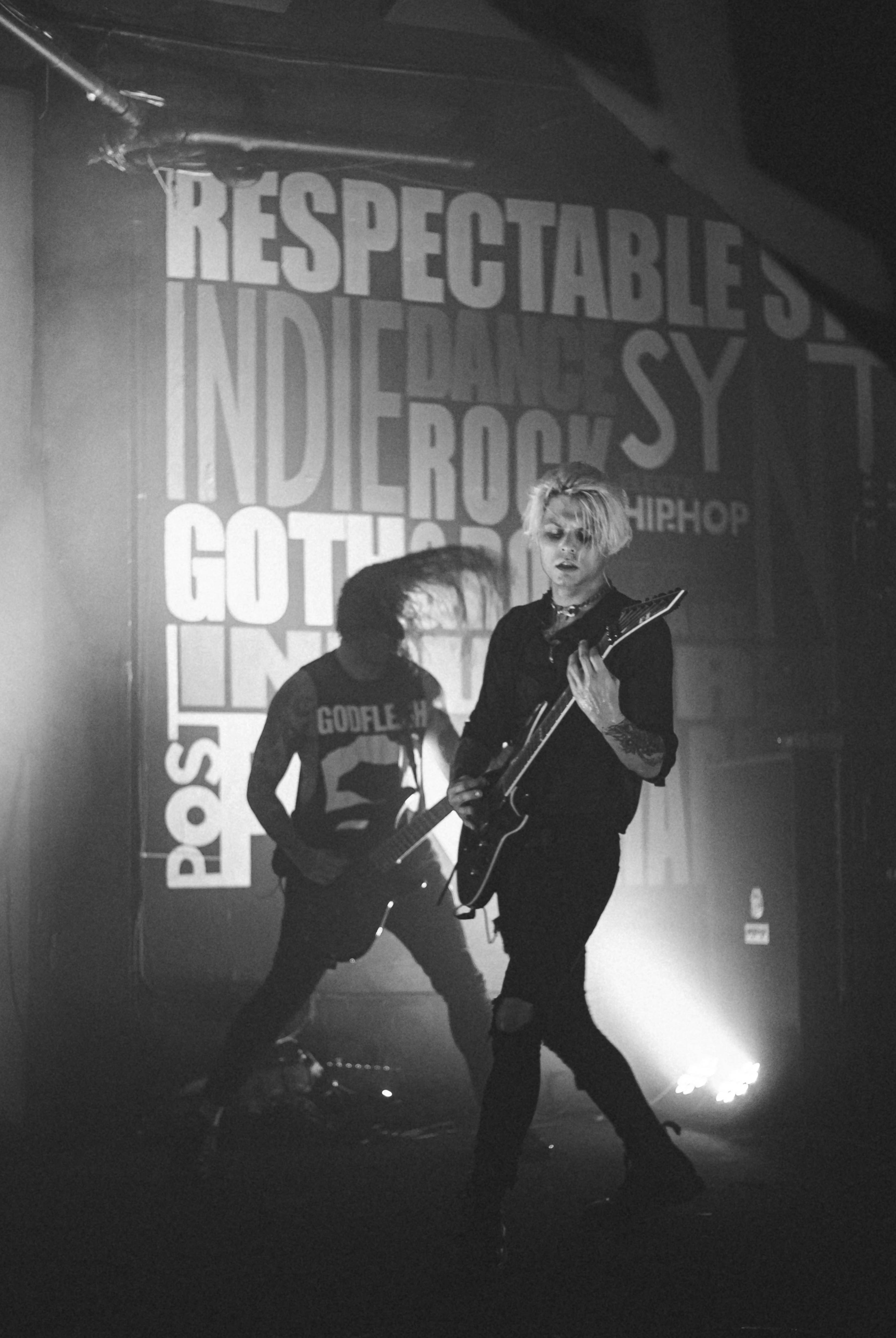 a couple of men playing guitars