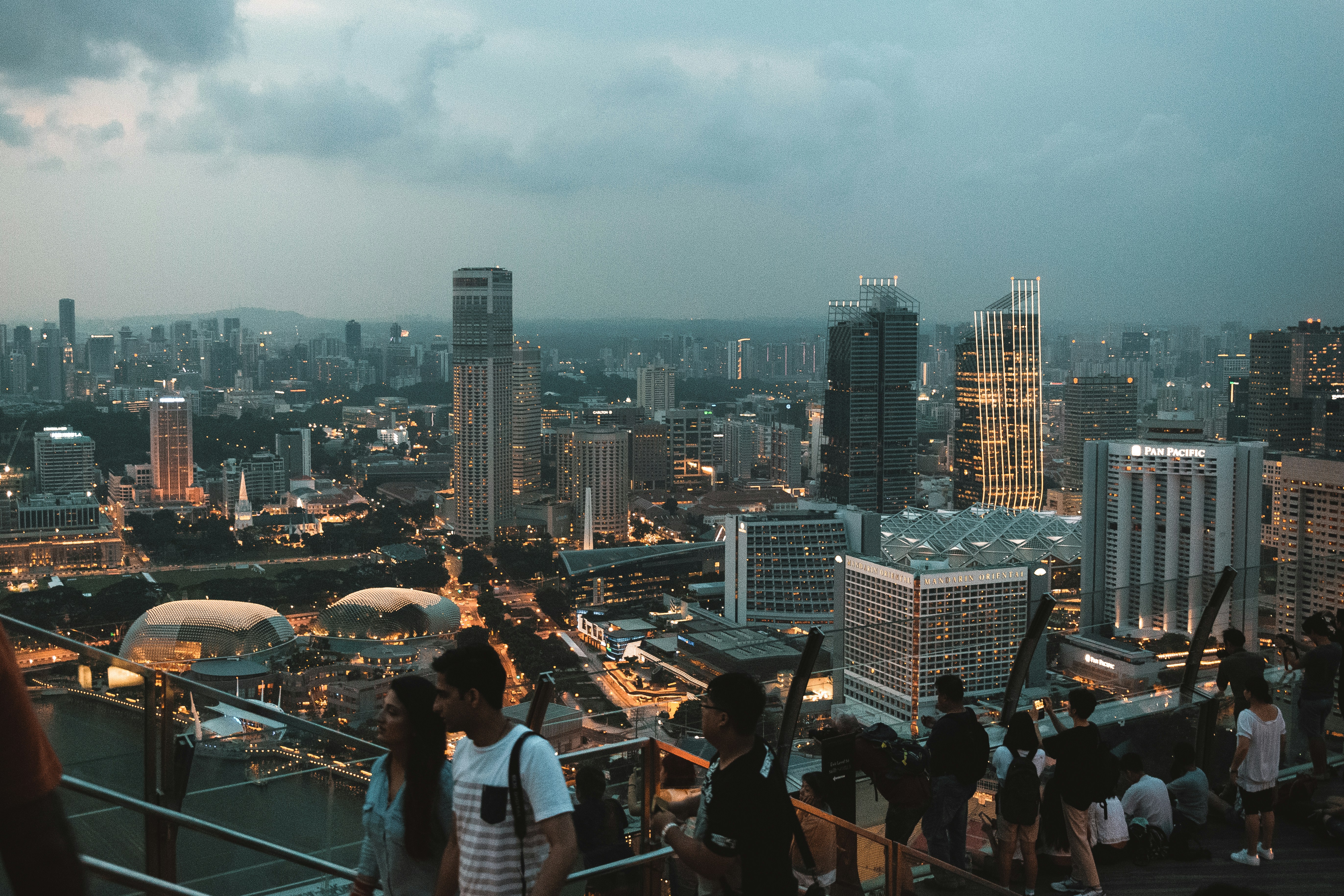 A group of people on a rooftop overlooking a city photo – Free ...