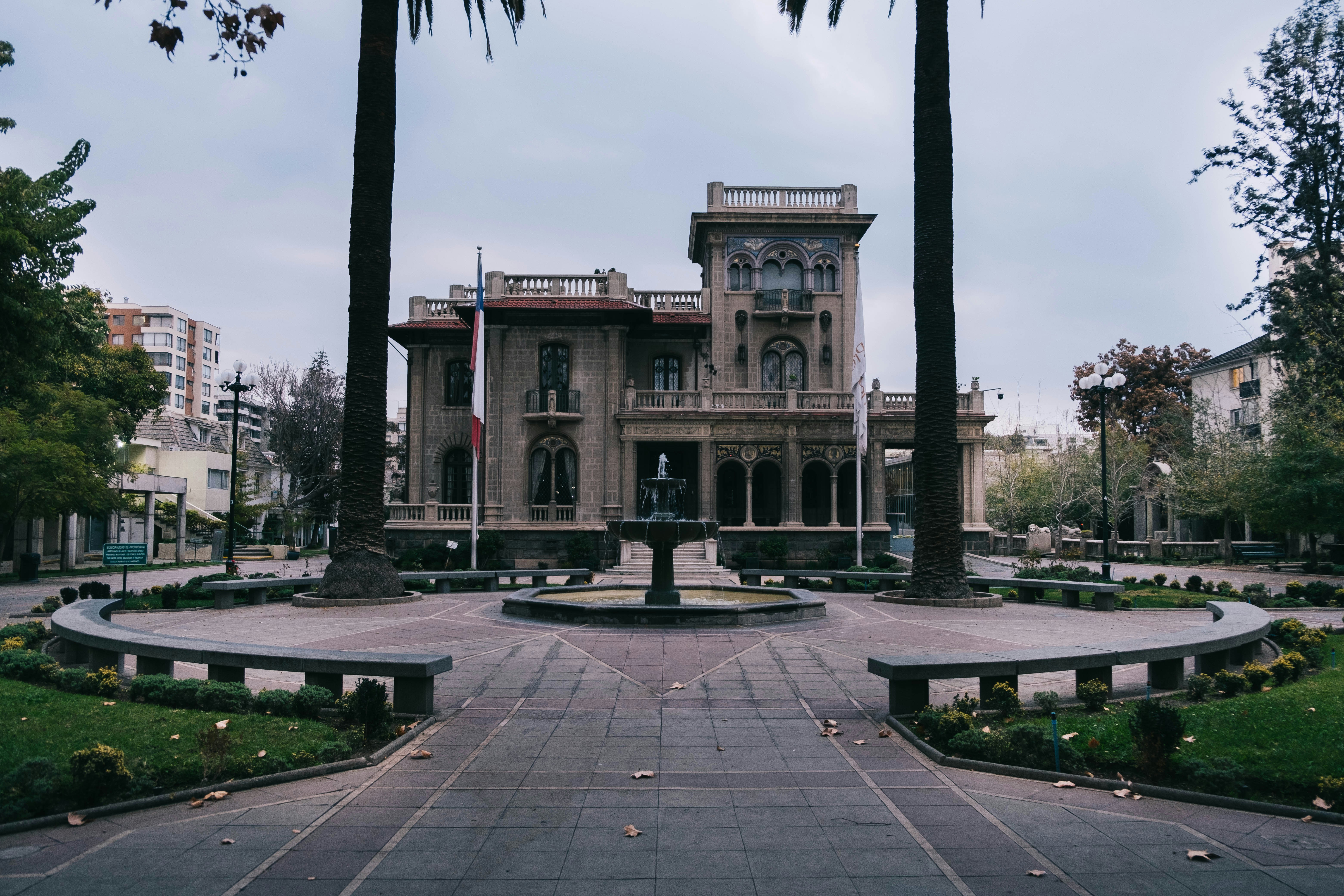 a large building with a fountain in front of it