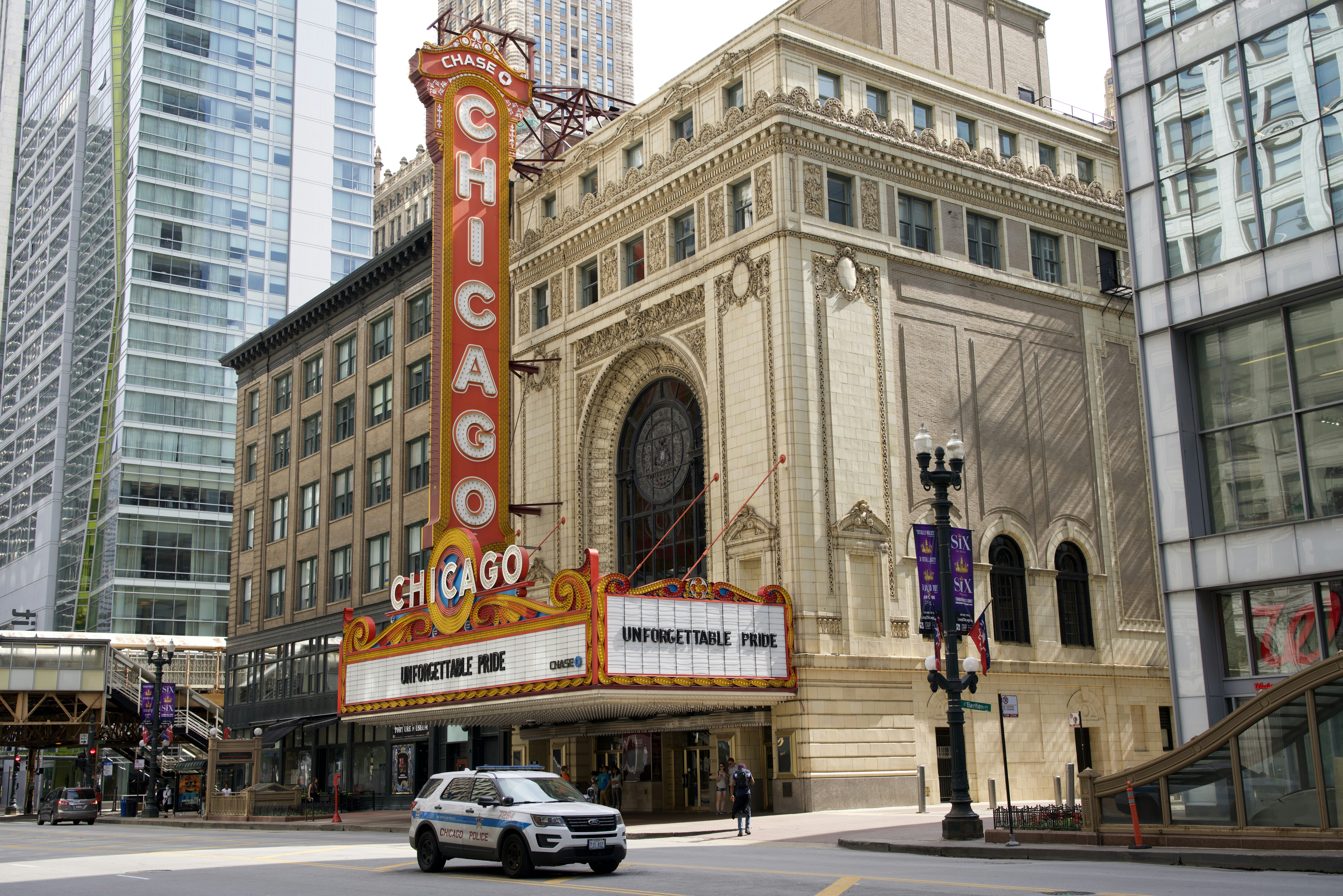 Neon Gatekeeper: The Chicago Theatre Amid a Modern Cityscape