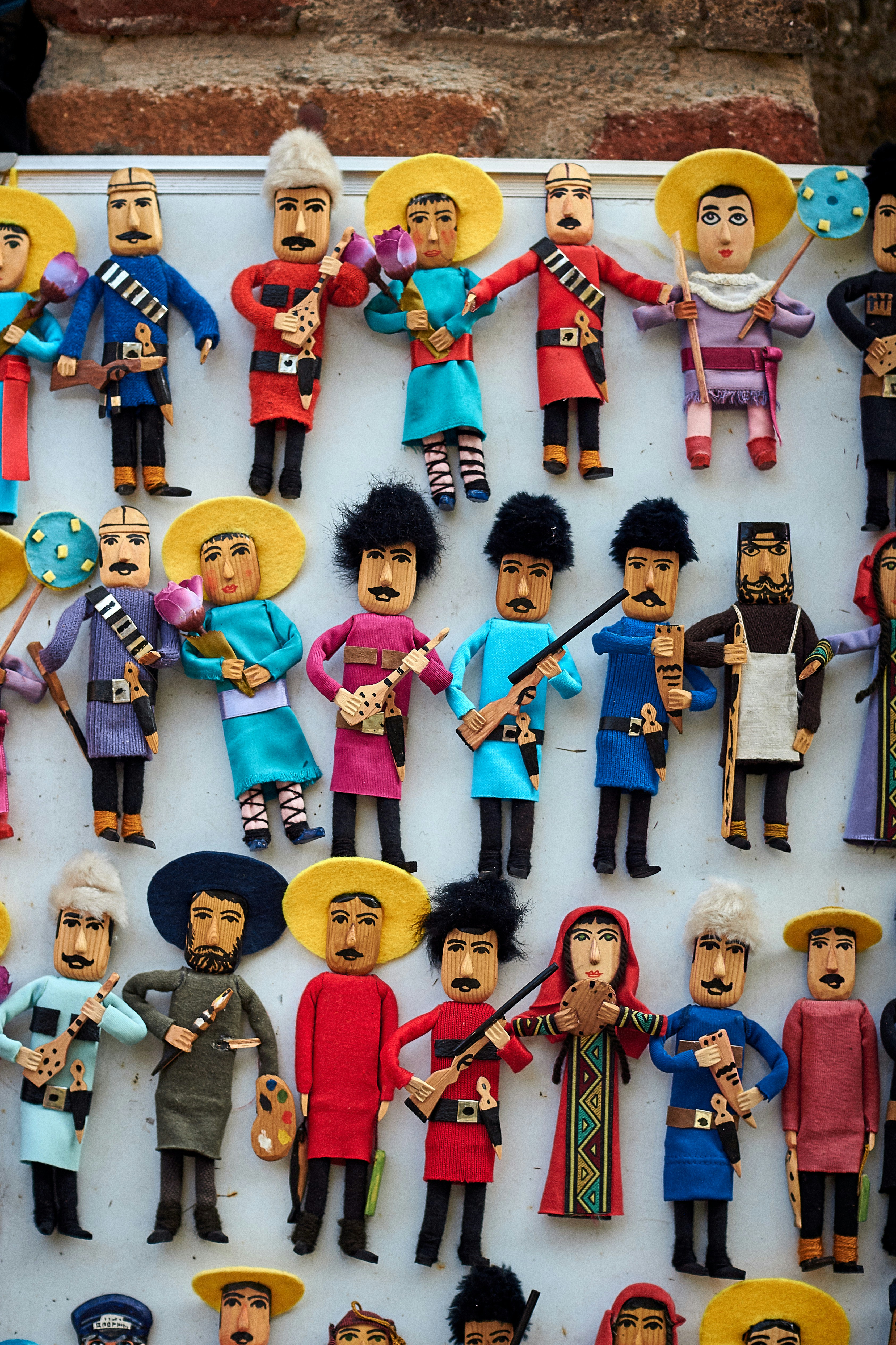 Colorful Papel Picado of Playful Soldiers: A Wall of Knitted Figurines with Musical Moments