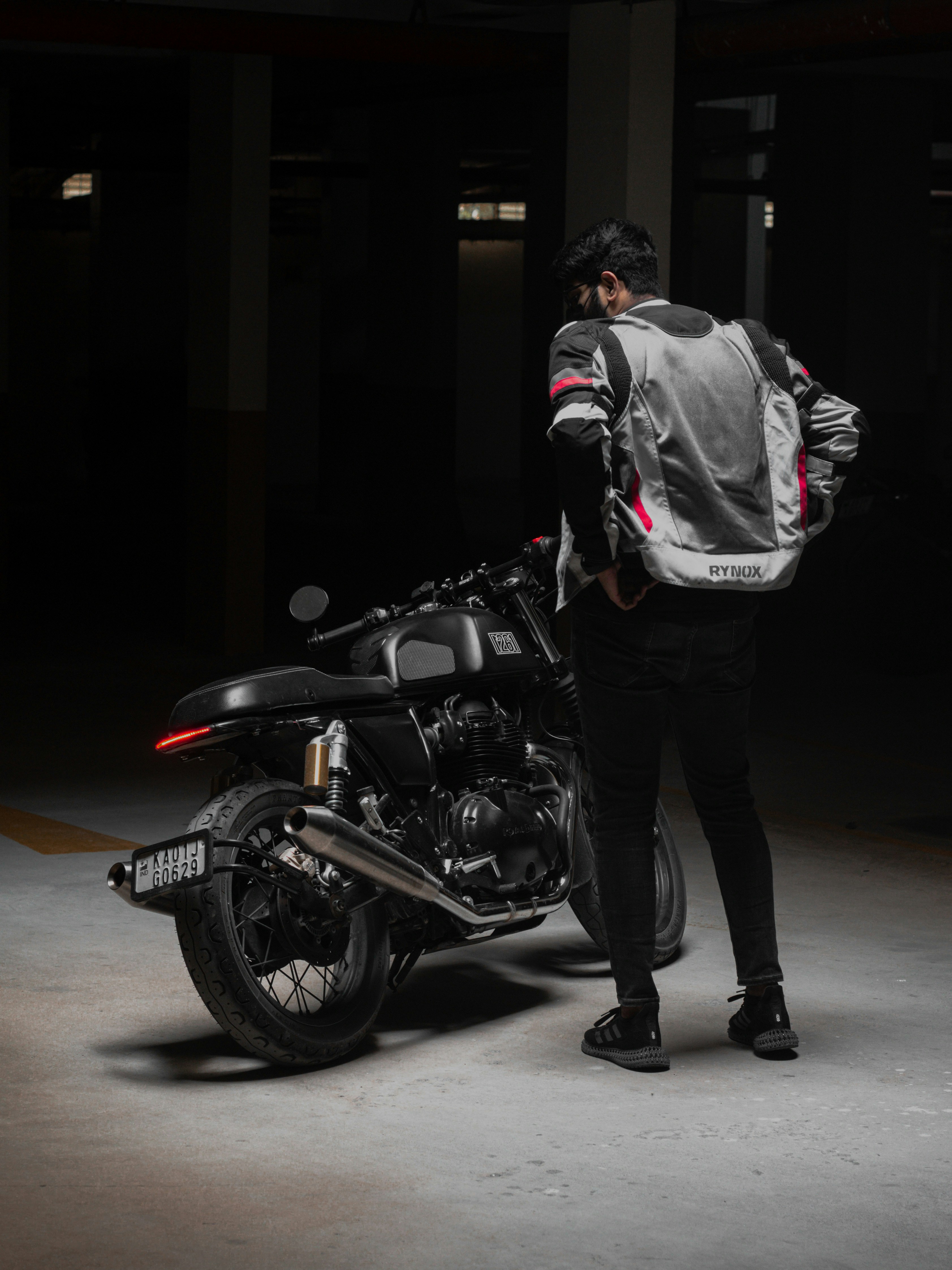 Rider in Shadow: A Backlit Moment with the Moto