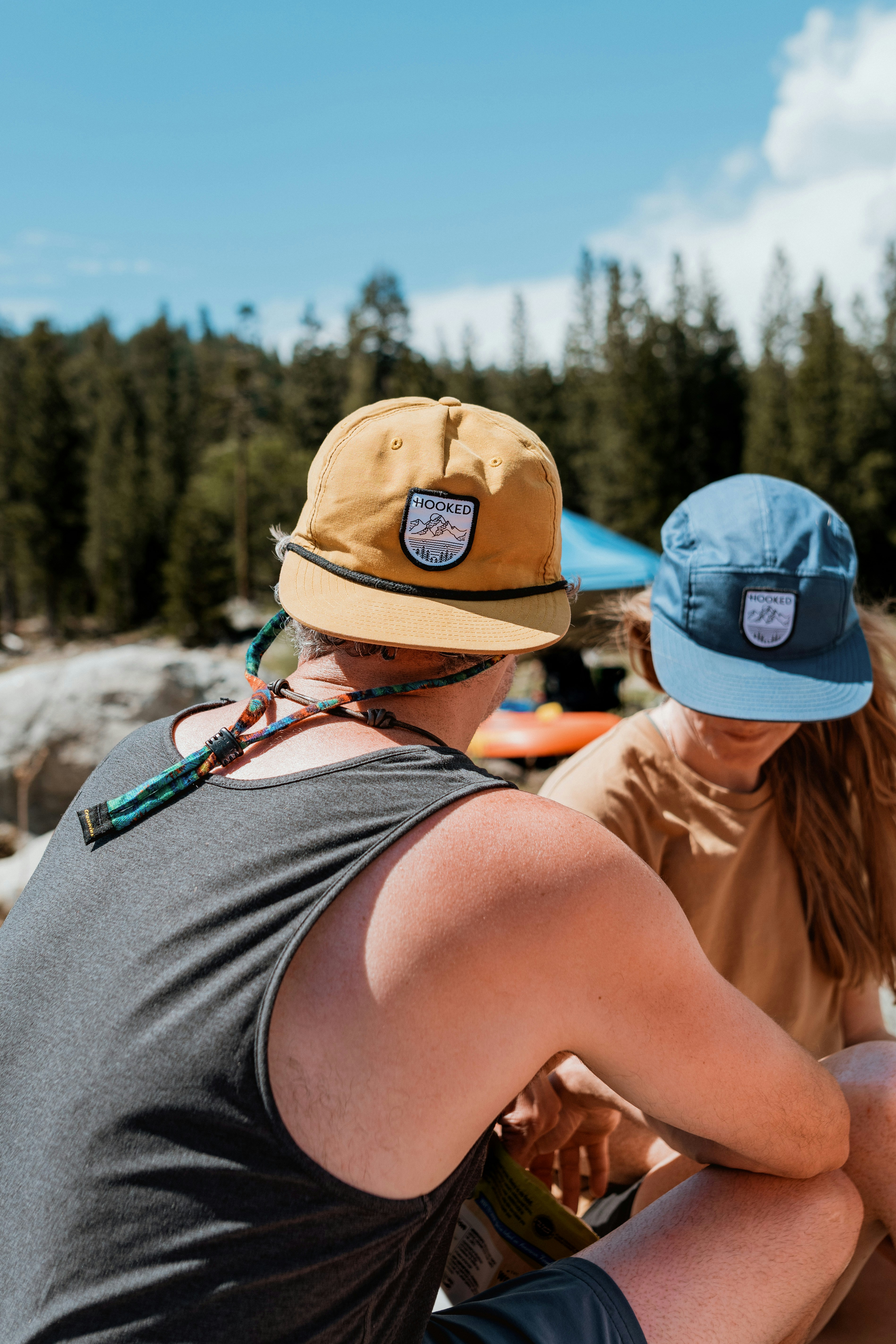 Two Campers Share a Moment: Sunlit Conversation by the River
