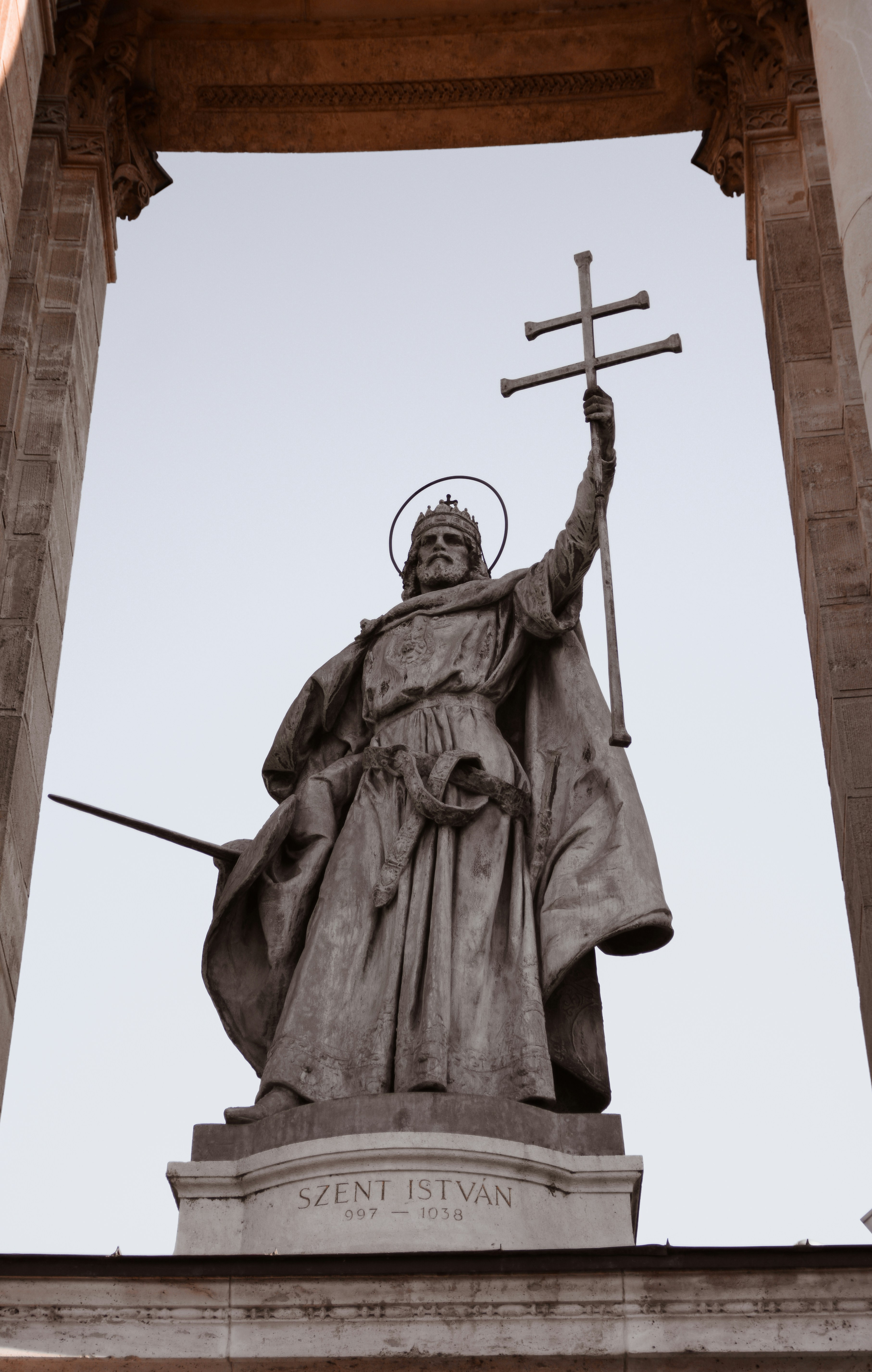 Haloed Saint Stephen Commands the Cross Beneath a Stone Arch