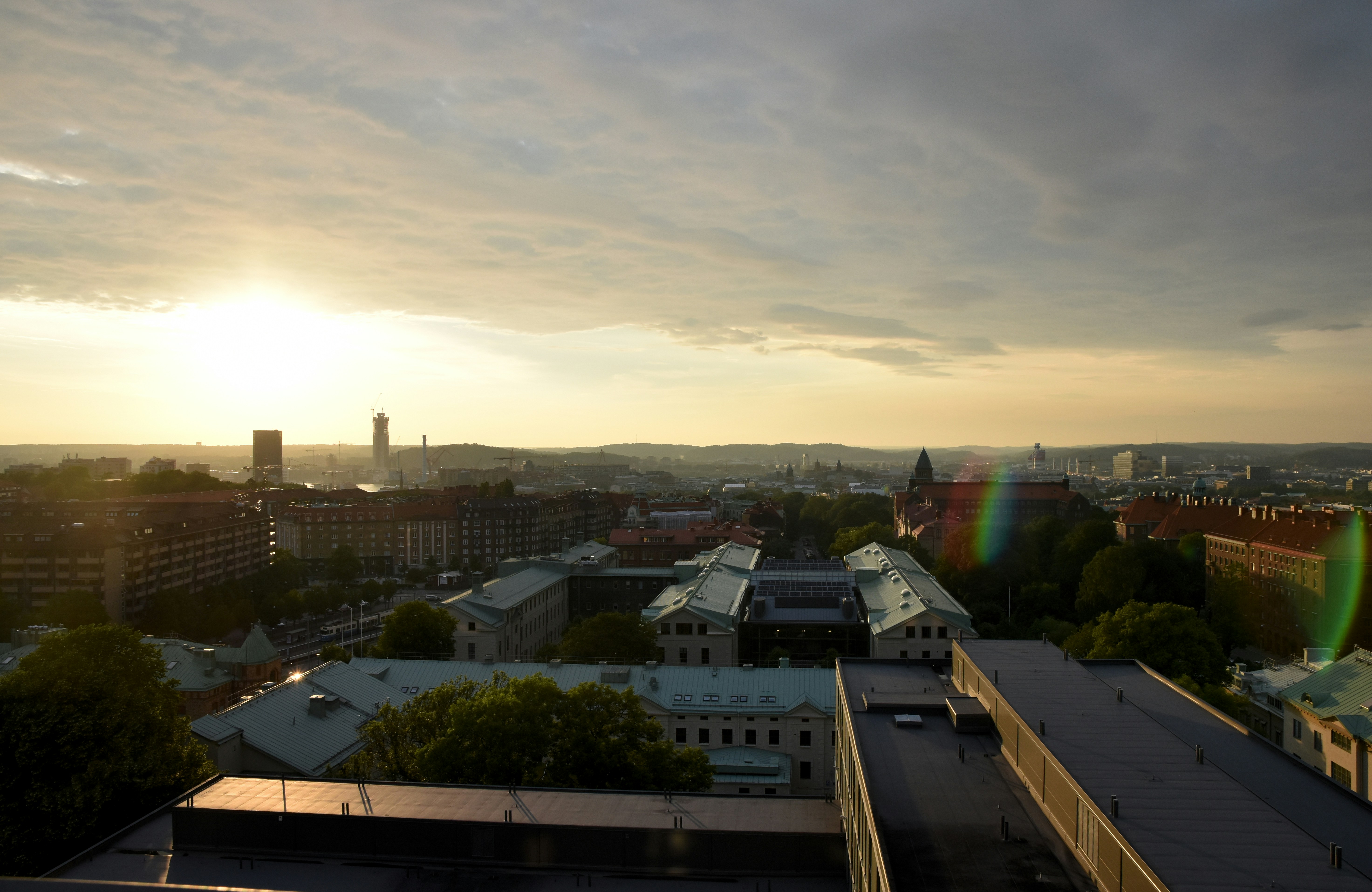 Sunset casting warm hues over the cityscape of Göteborg, with a mix of modern and historic architecture.