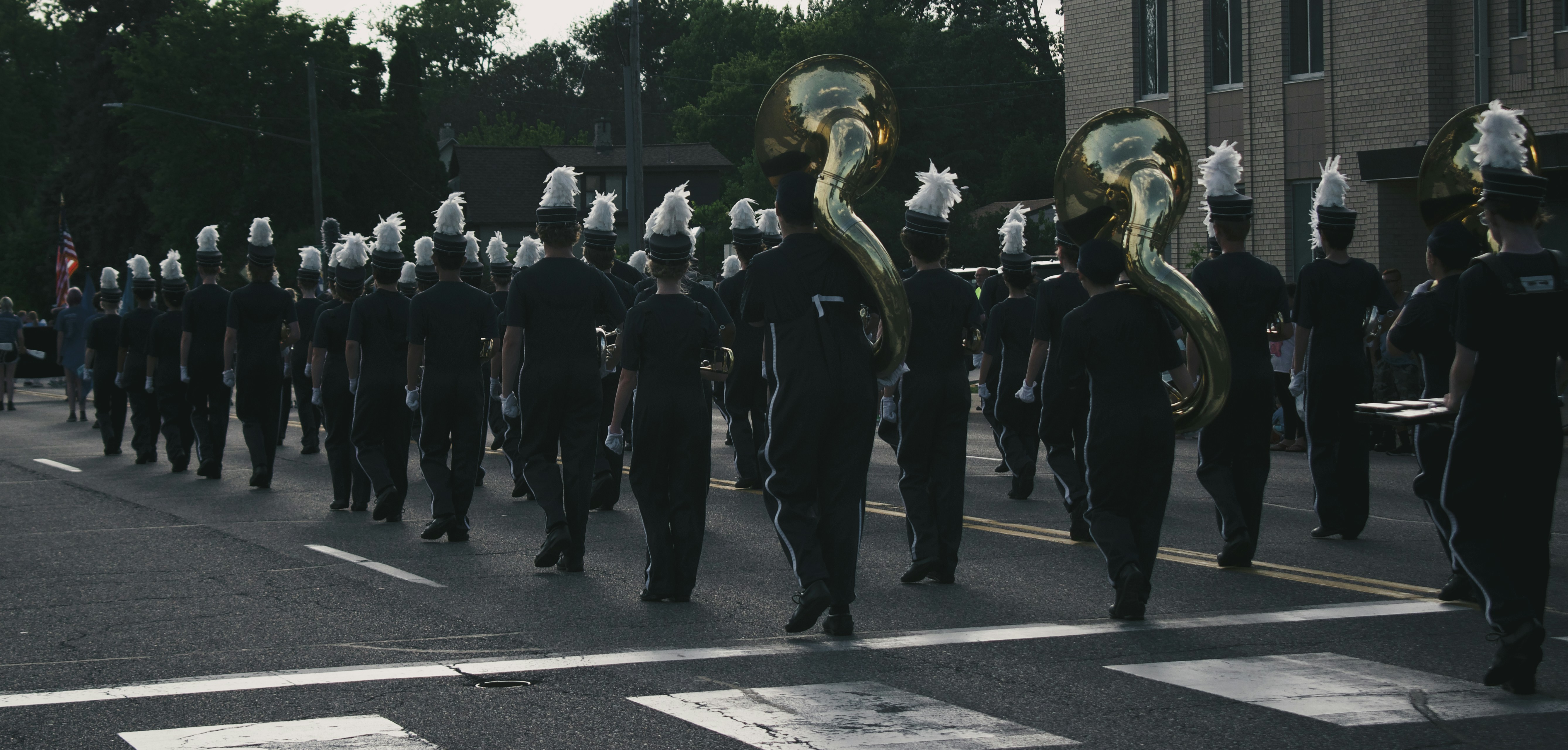 A group of people in uniform marching photo – Free Black Image on Unsplash