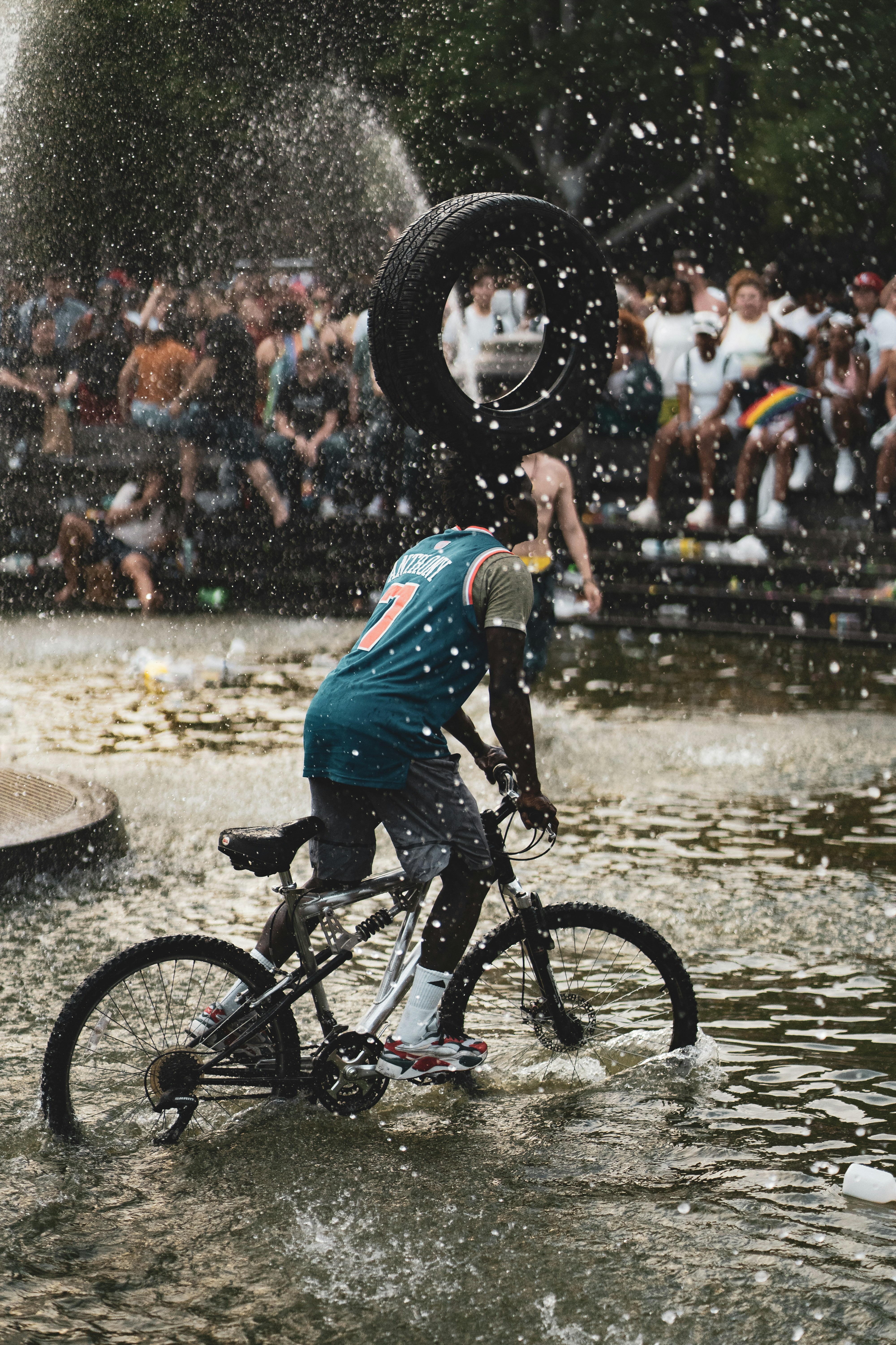 Tire Swing: BMX Rider through a Water Obstacle at a Street Festival