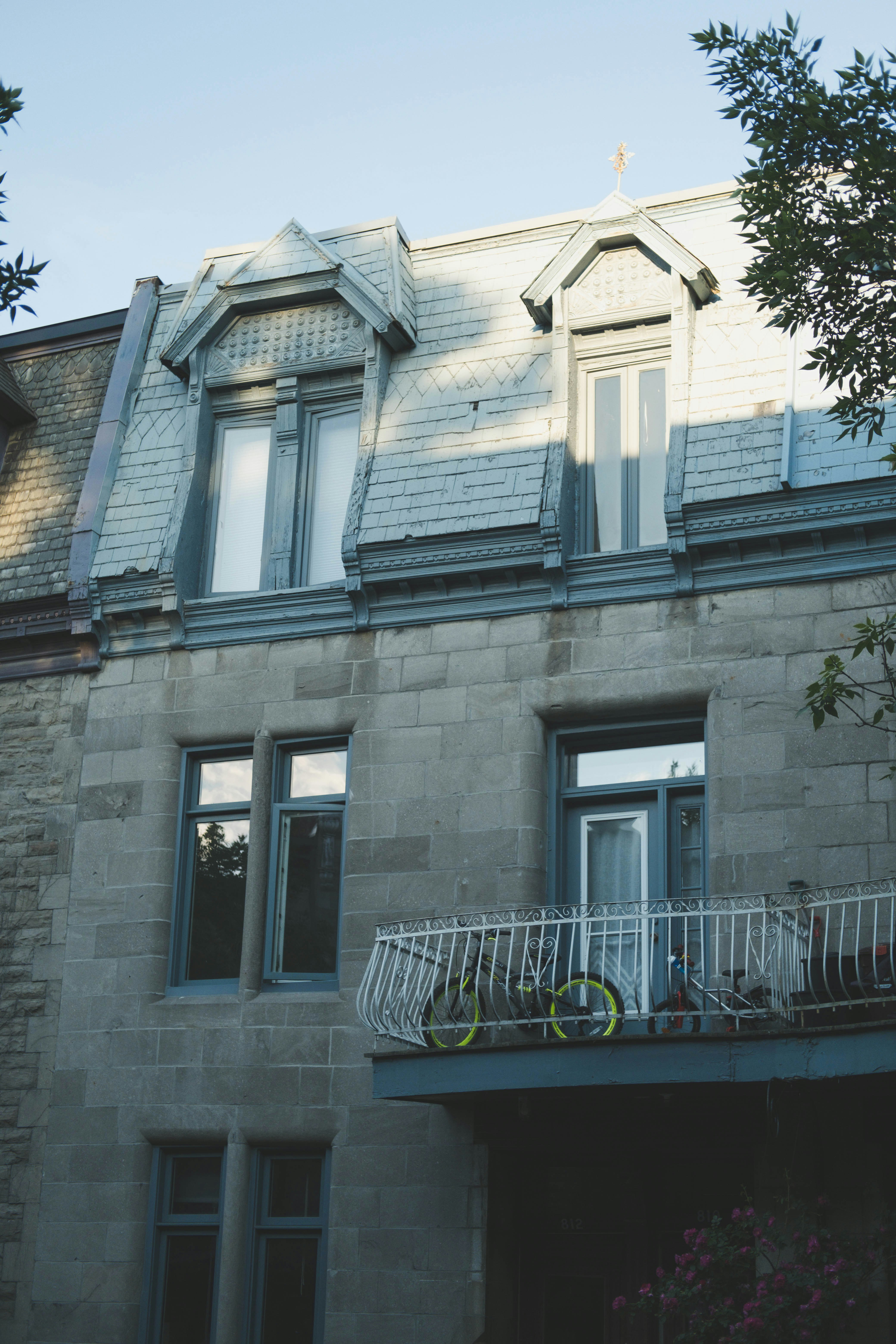 Sunlit Mansard Windows: A Quiet Facade in Soft Evening Light
