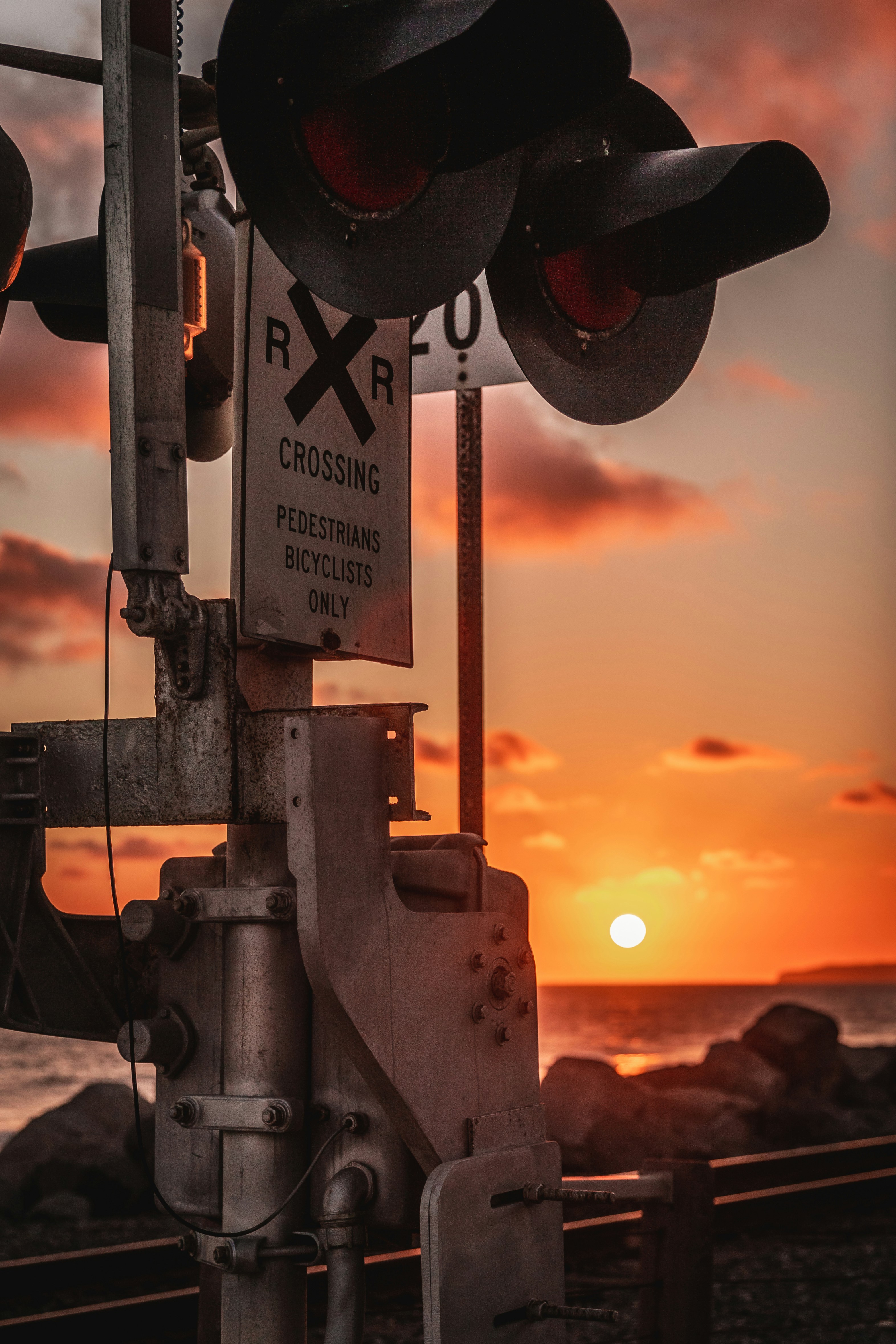 Sunset Rail Signal: A Quiet Crossing by the Sea