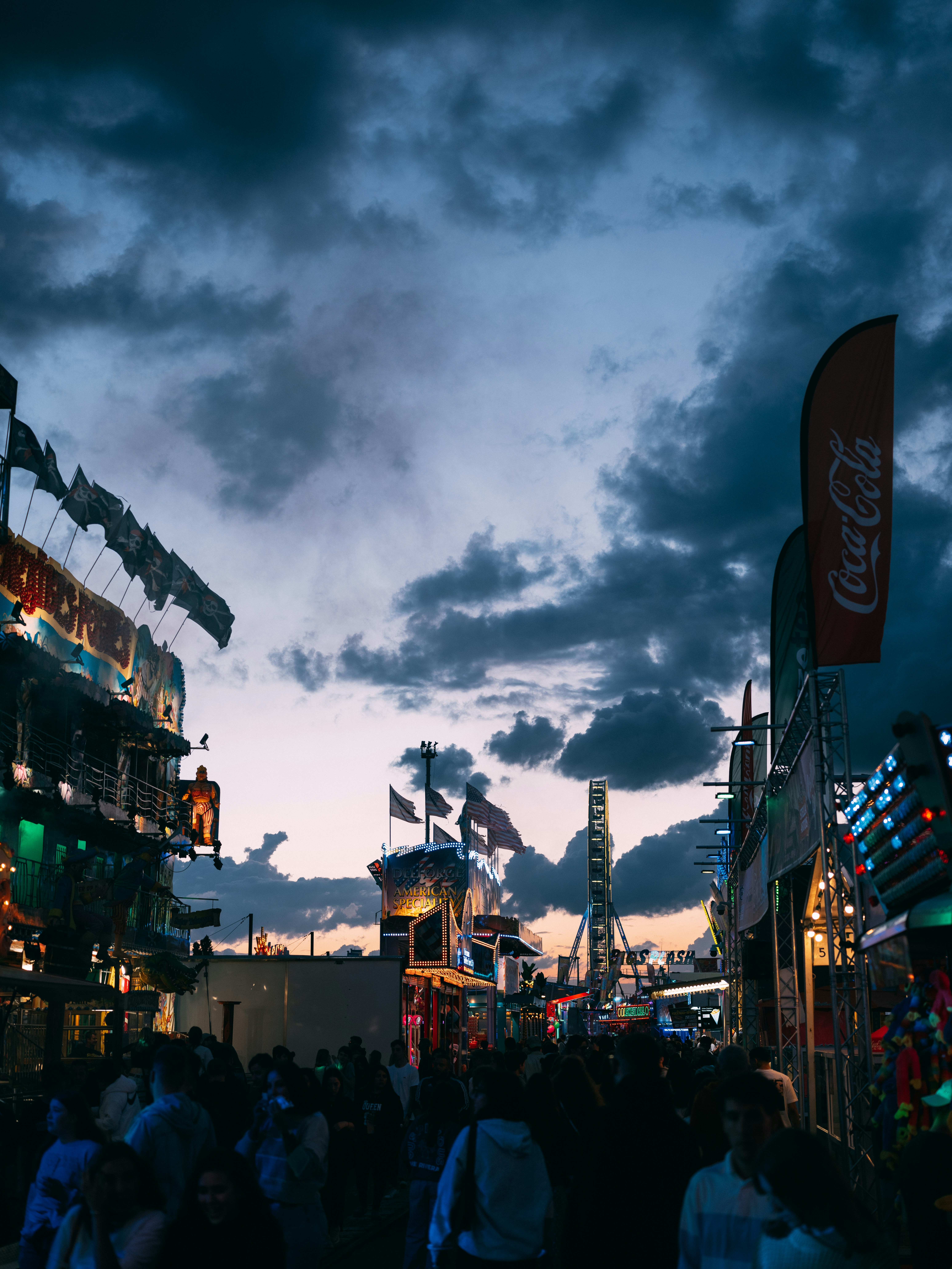 Evening Glow Over the Fair: Neon Lights and Dusk-Charged Crowd