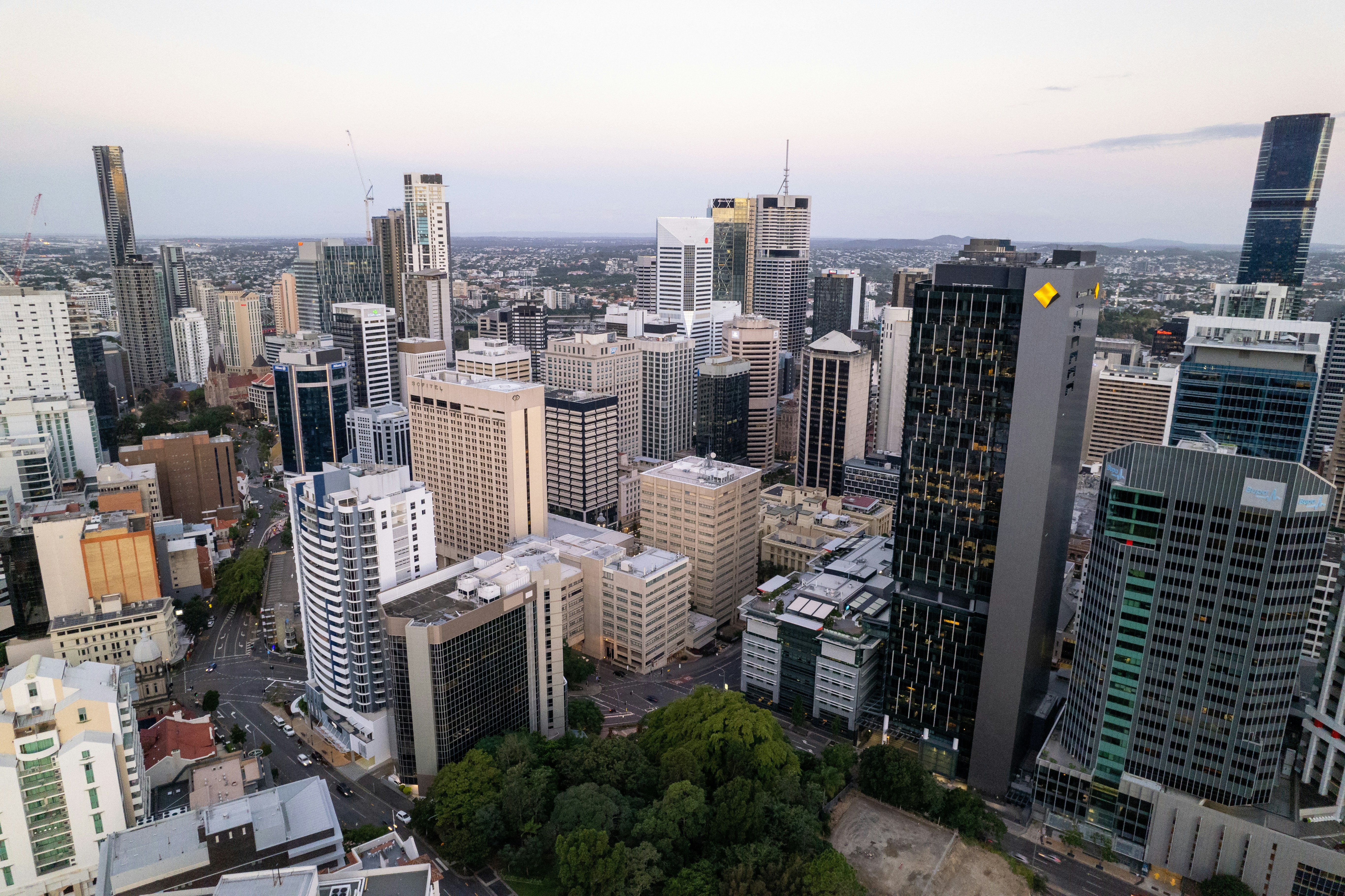 Aerial view of a bustling city skyline showcasing a blend of modern skyscrapers and green spaces.