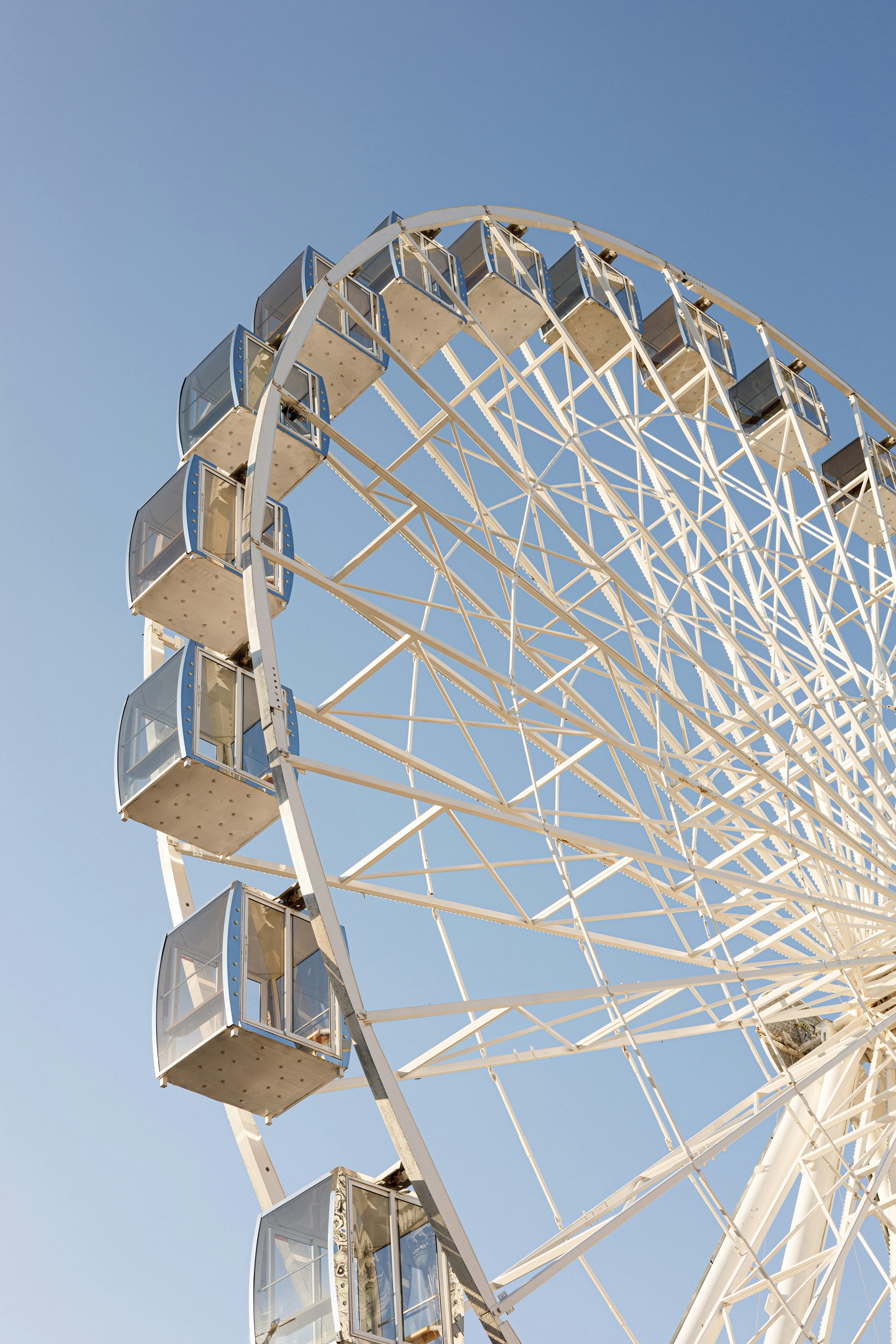 Geometric Serenity: A White Ferris Wheel Encircling Azure