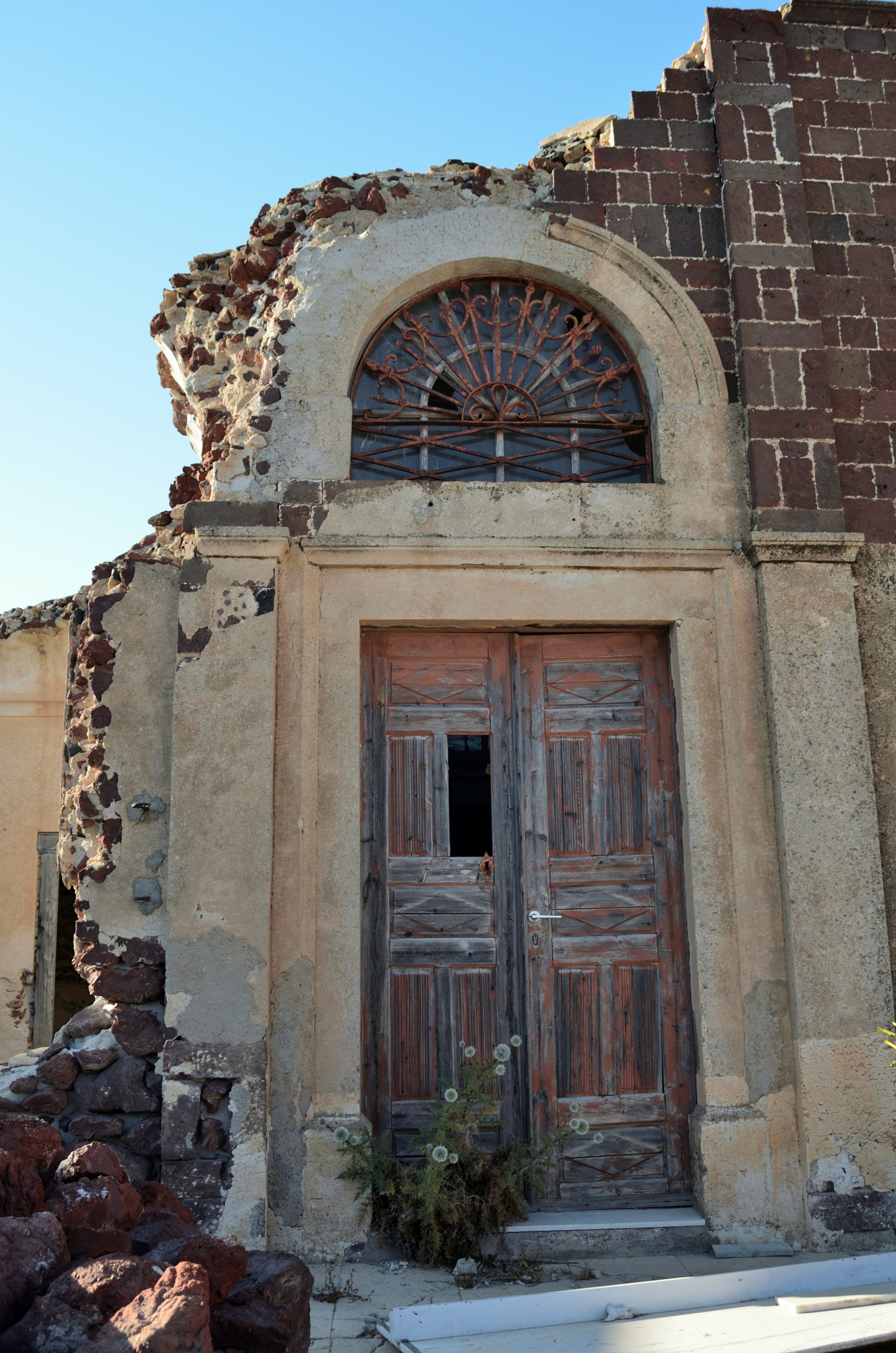 Weathered Threshold: Sunlit Arch Framing a Crumbling Portal