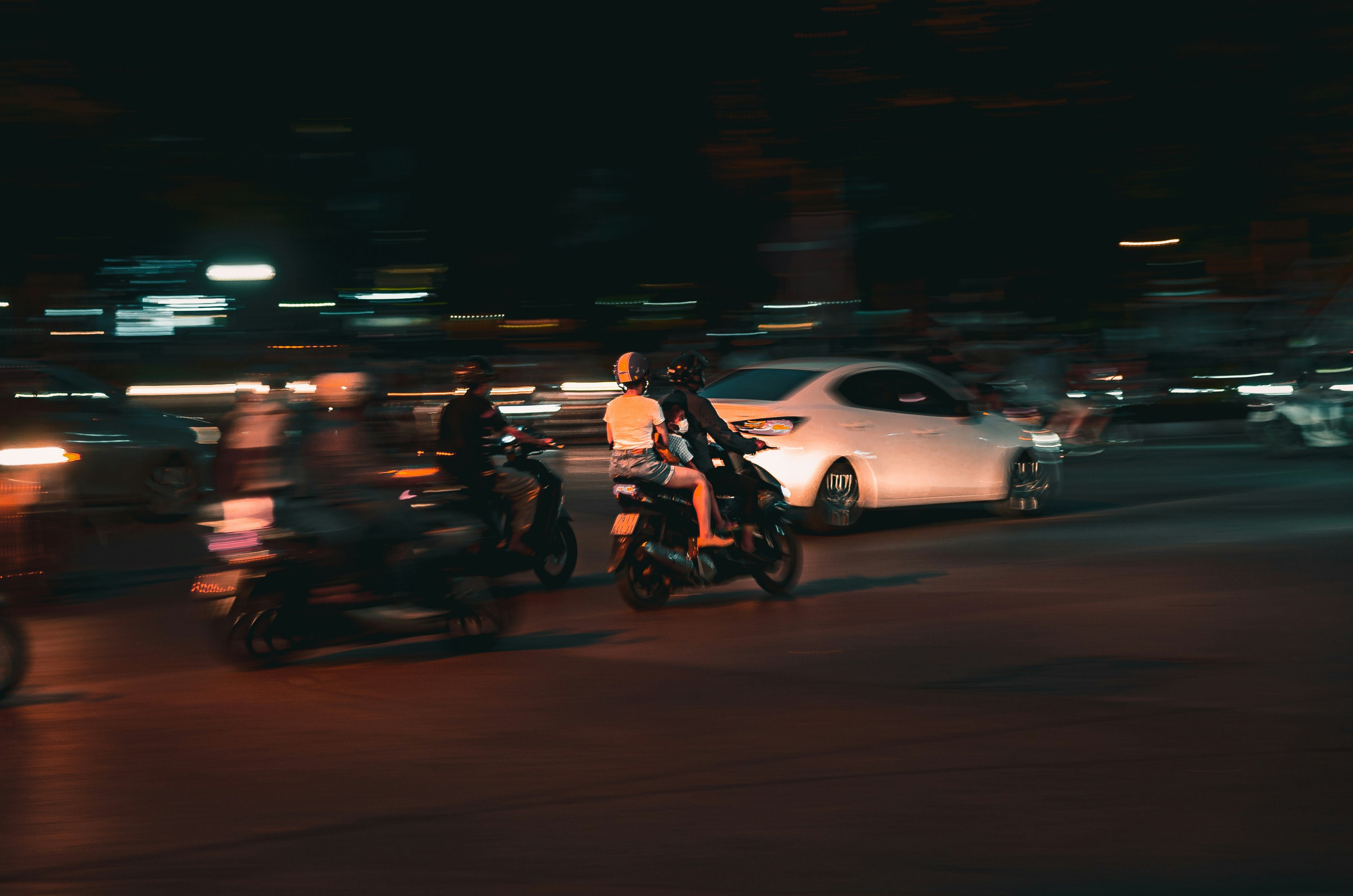 A group of people riding motorcycles at night photo – Free Vietnam ...