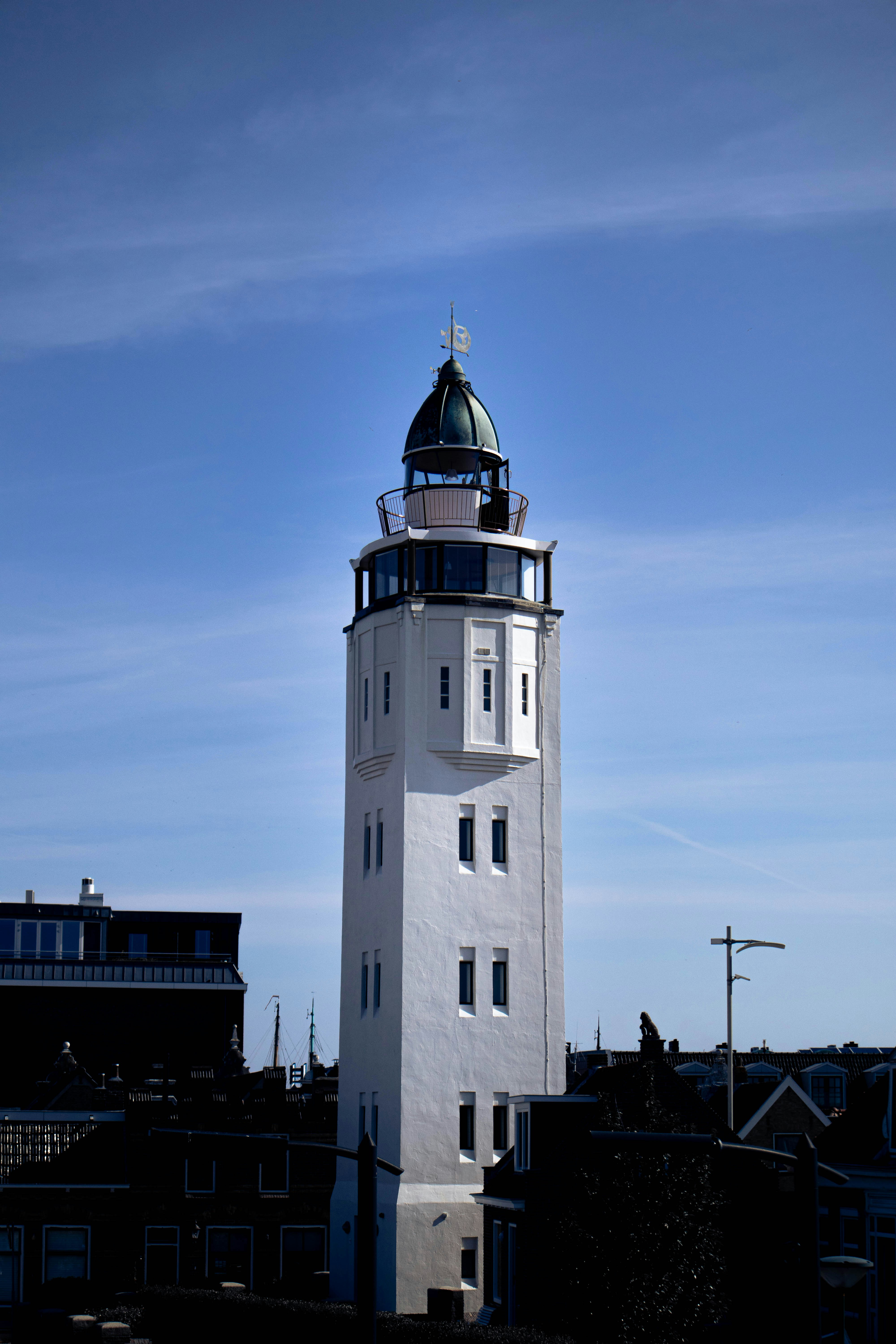 a white tower with a blue sky with South Foreland Lighthouse in the background