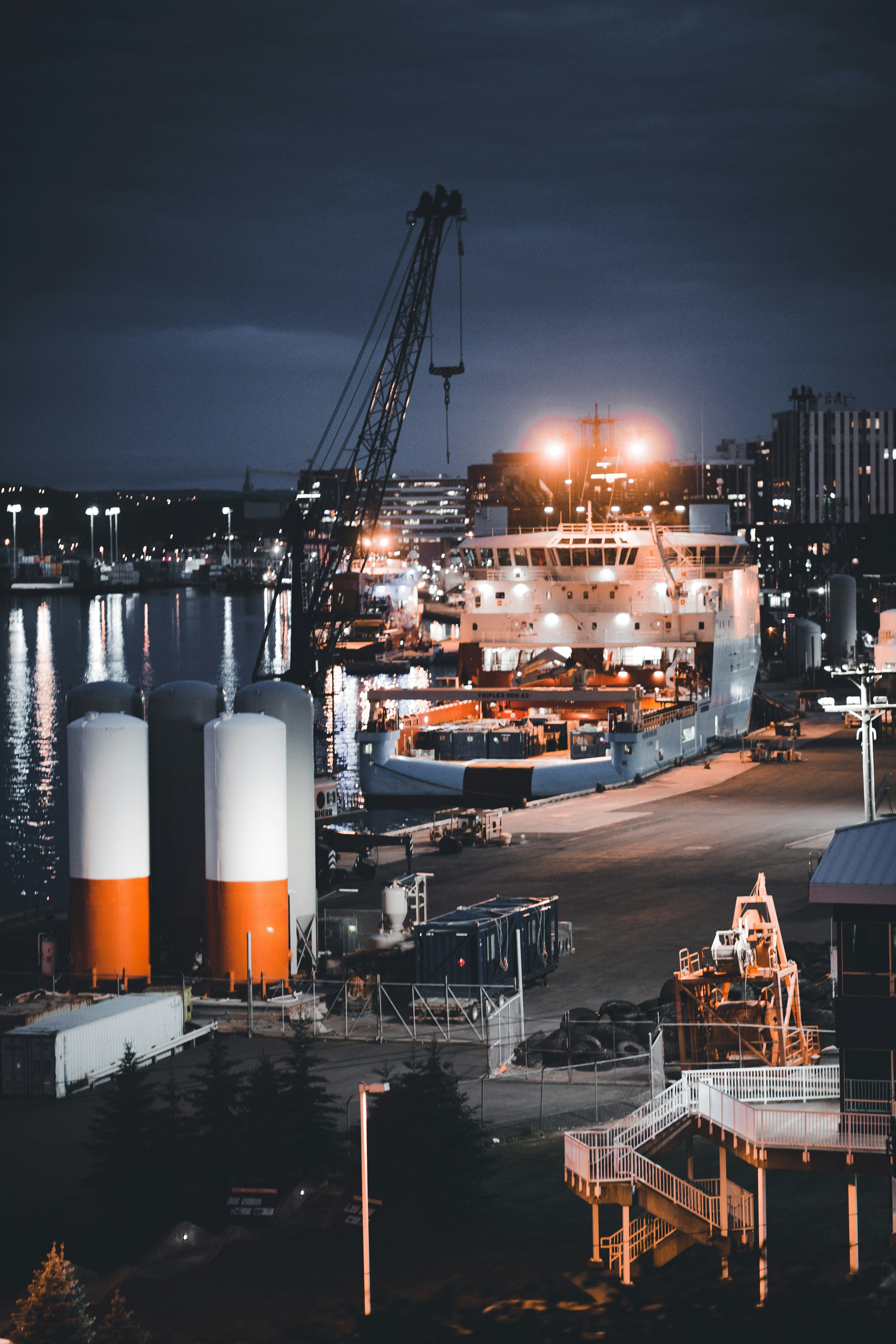 Night Shift at the Harbor: An Illuminated Vessel Framed by a Crane