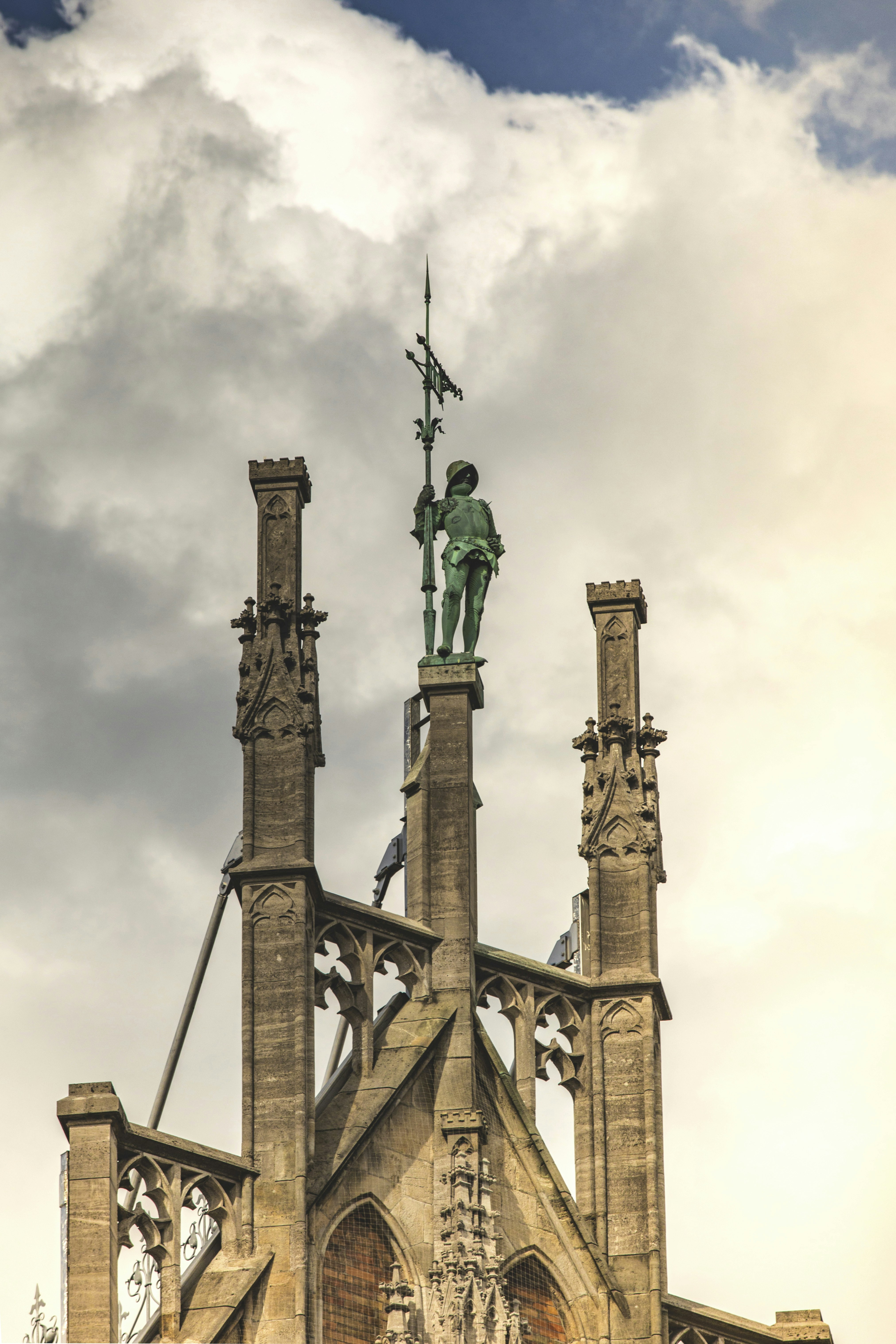 Gothic Summit: A Statue Reigns Amid Spire Illuminations
