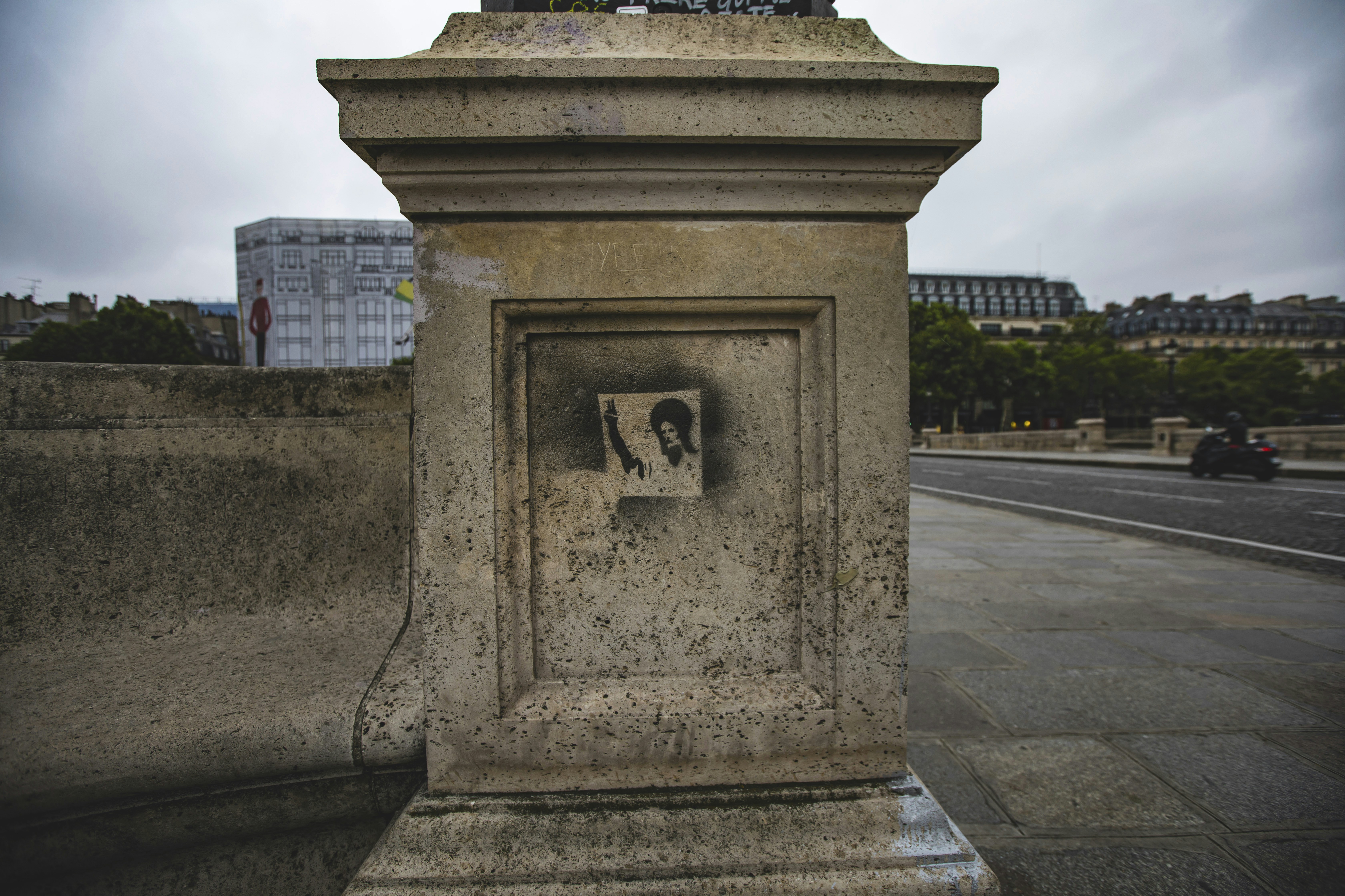 A stone pillar with a face carved into it photo – Free Grey Image on ...