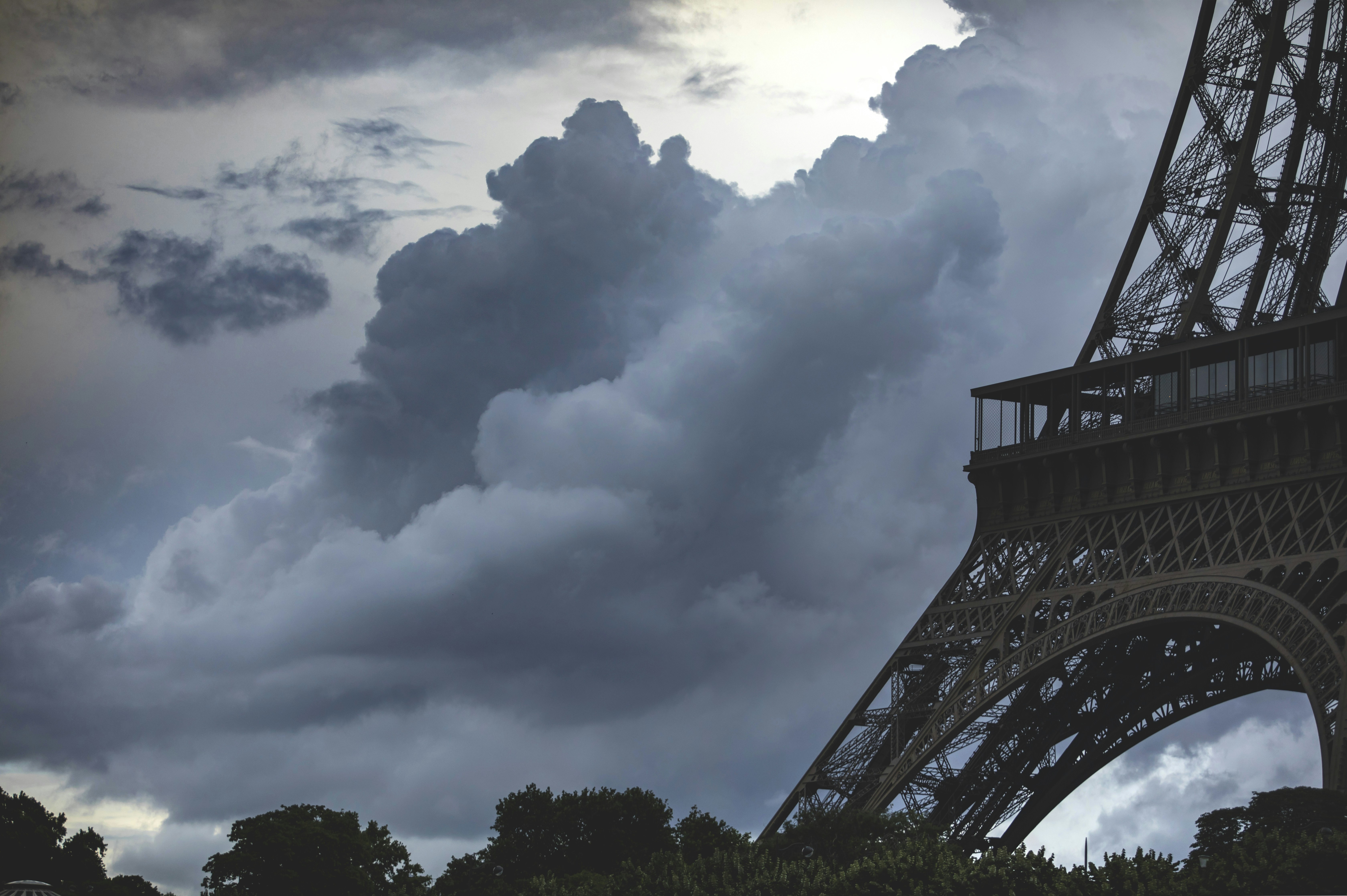Eiffel Quiet: Cloud-chased Iron Over the Treetops