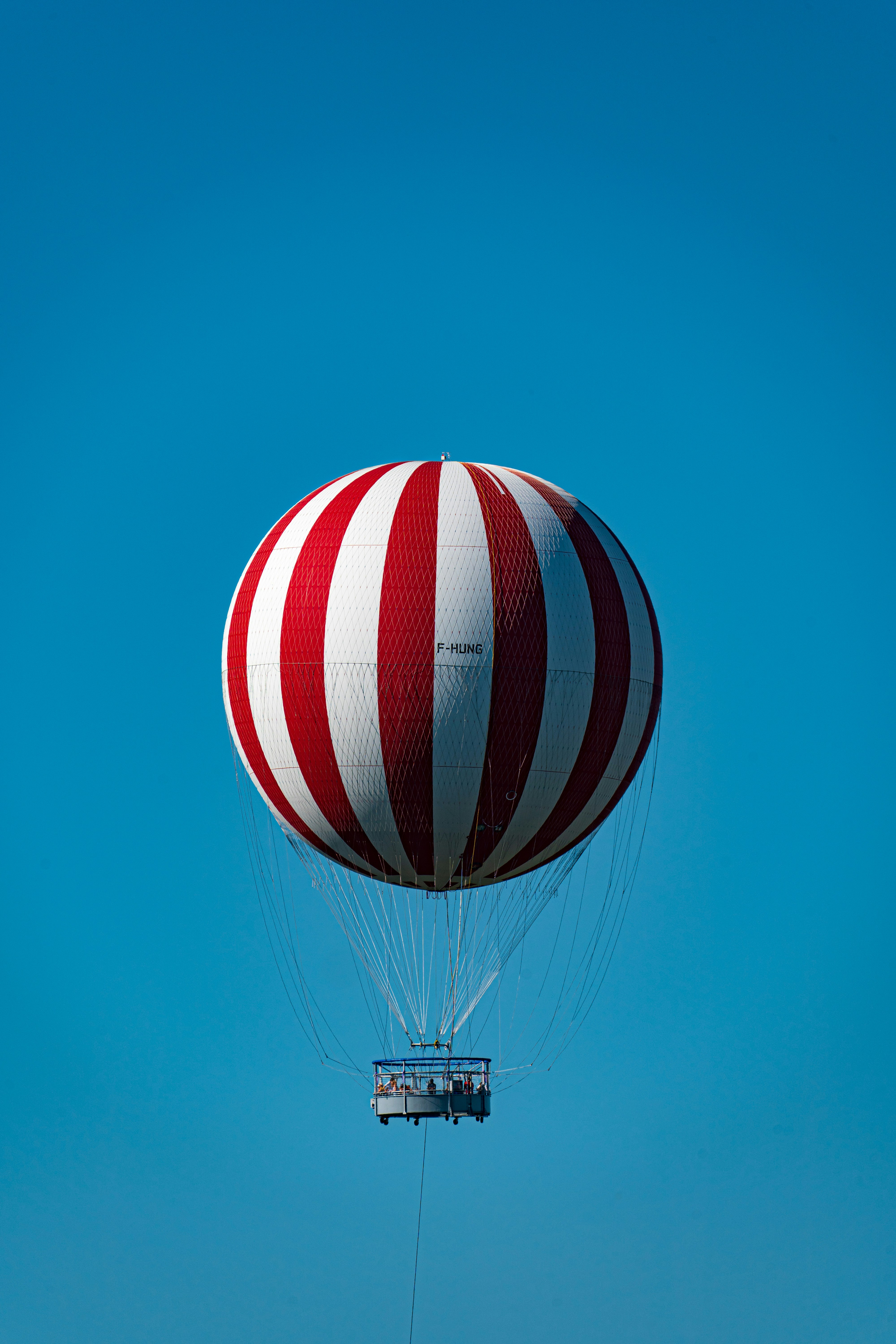 Cerulean Sky Carrier: a Red-and-White Balloon Aloft